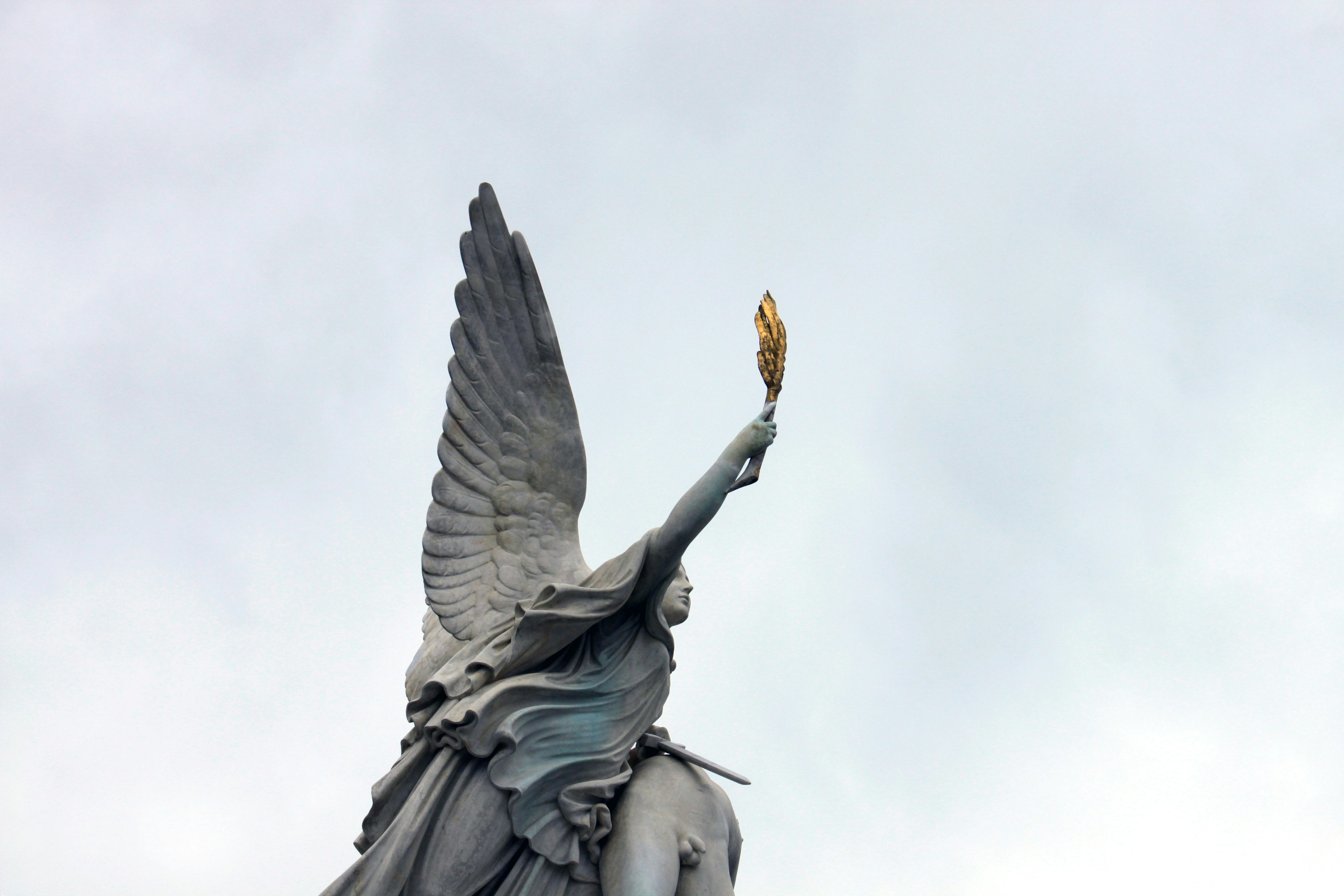 Winged Reach: A Crowned Figure Embracing the Flame