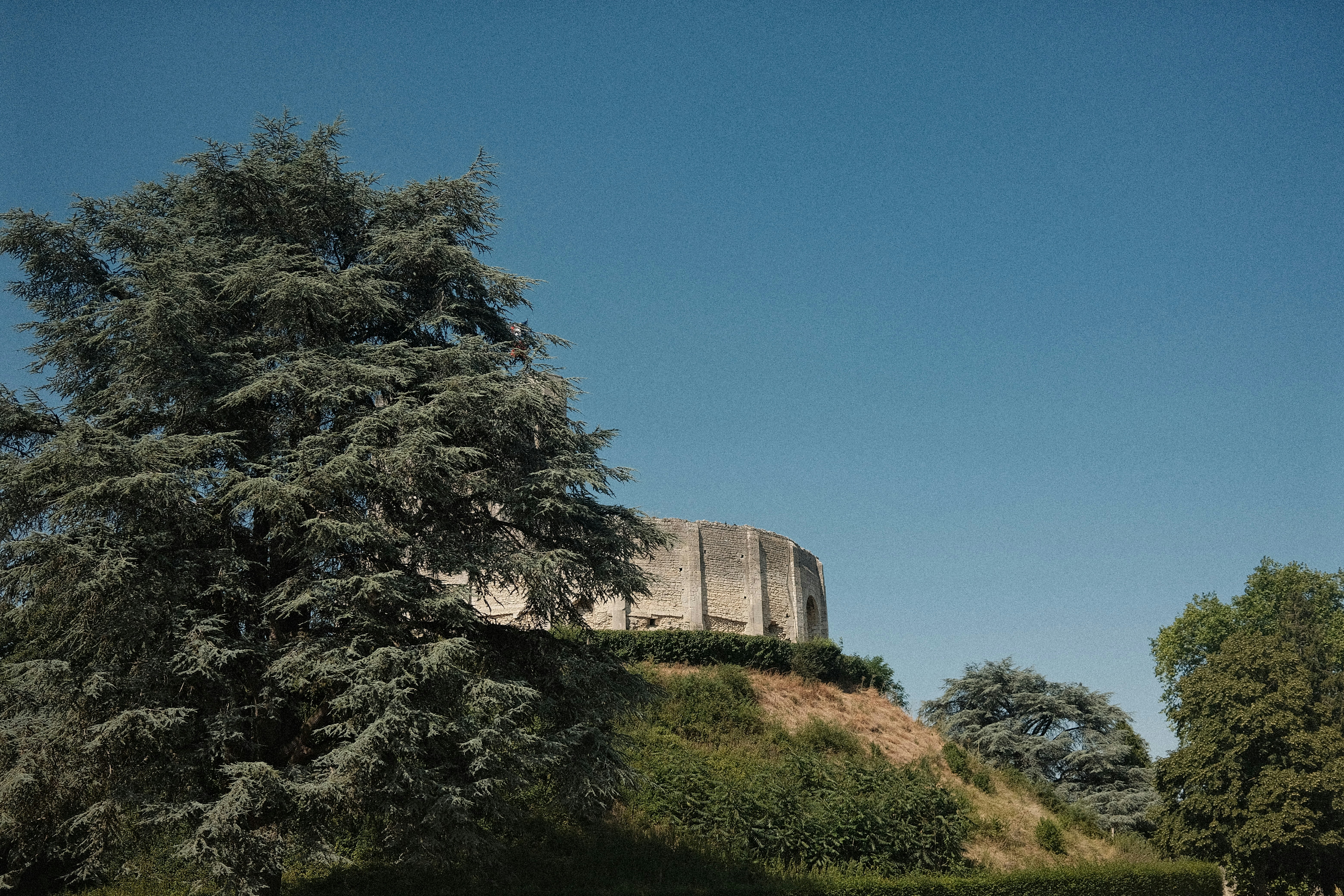 Fortress on the Hill: A Stone Sentinel Over Green Slopes
