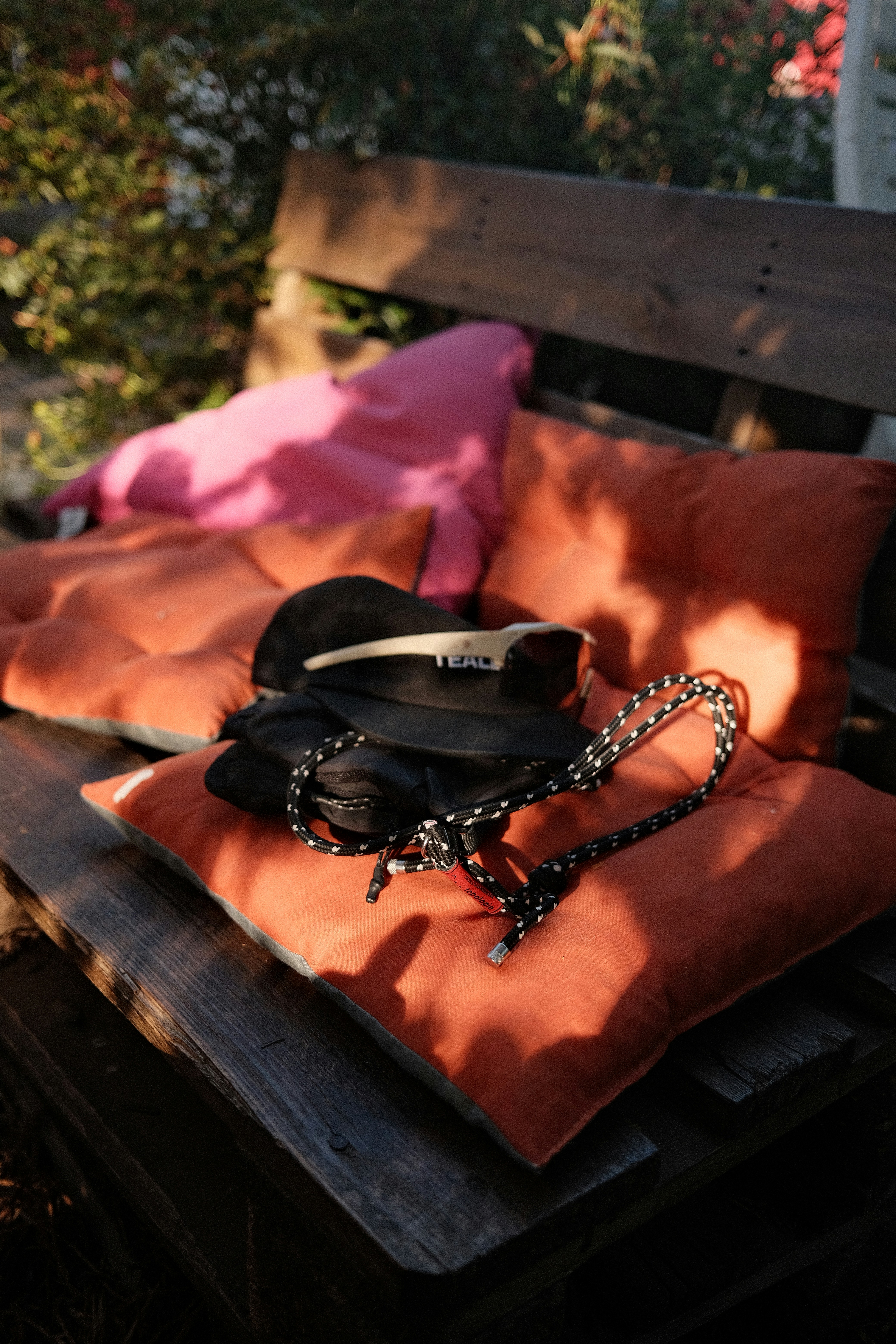 Sunlit Cushions and Gear on a Rustic Bench