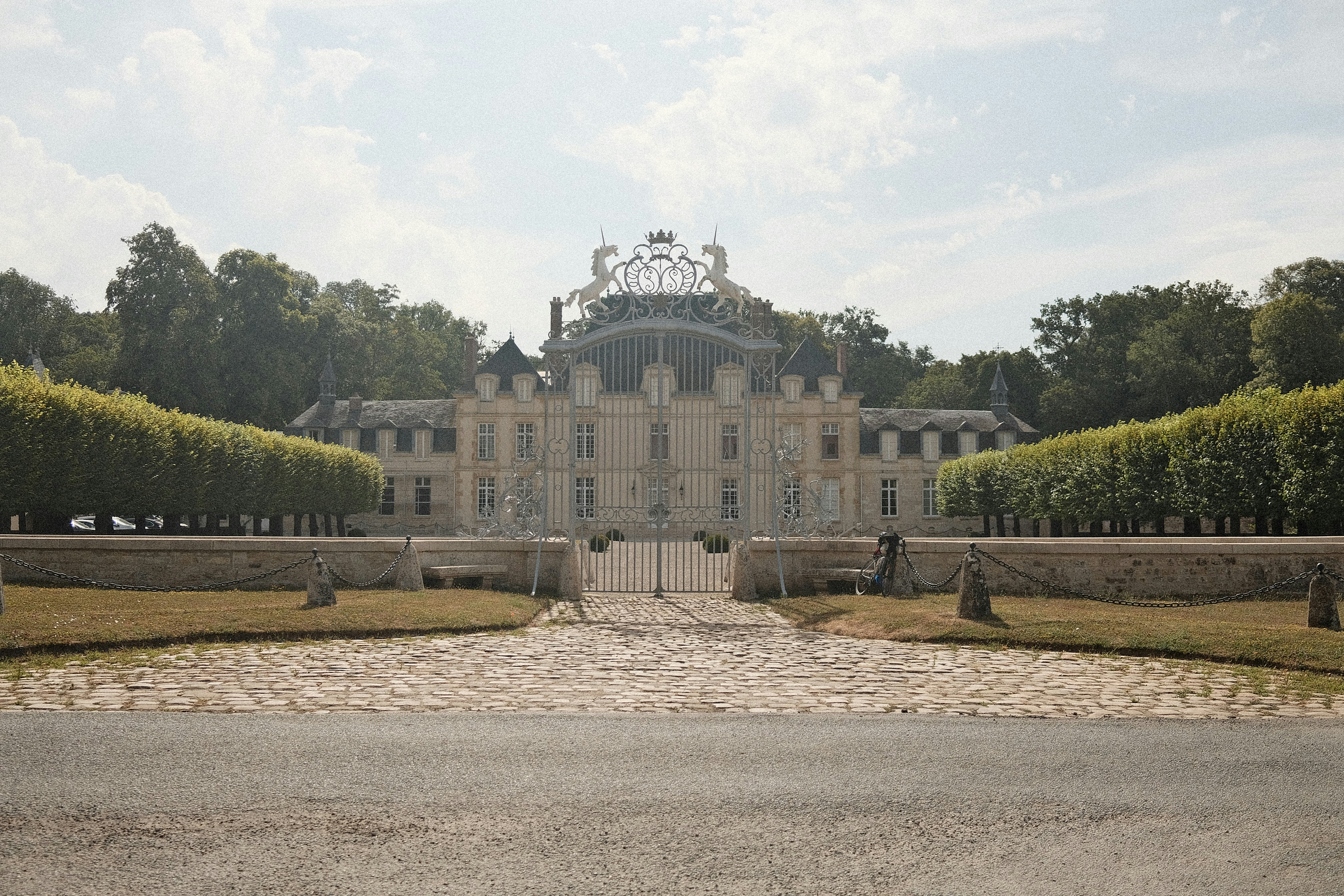 Ivory Gatekeepers: A Symmetrical Courtyard to the Grand Chateau