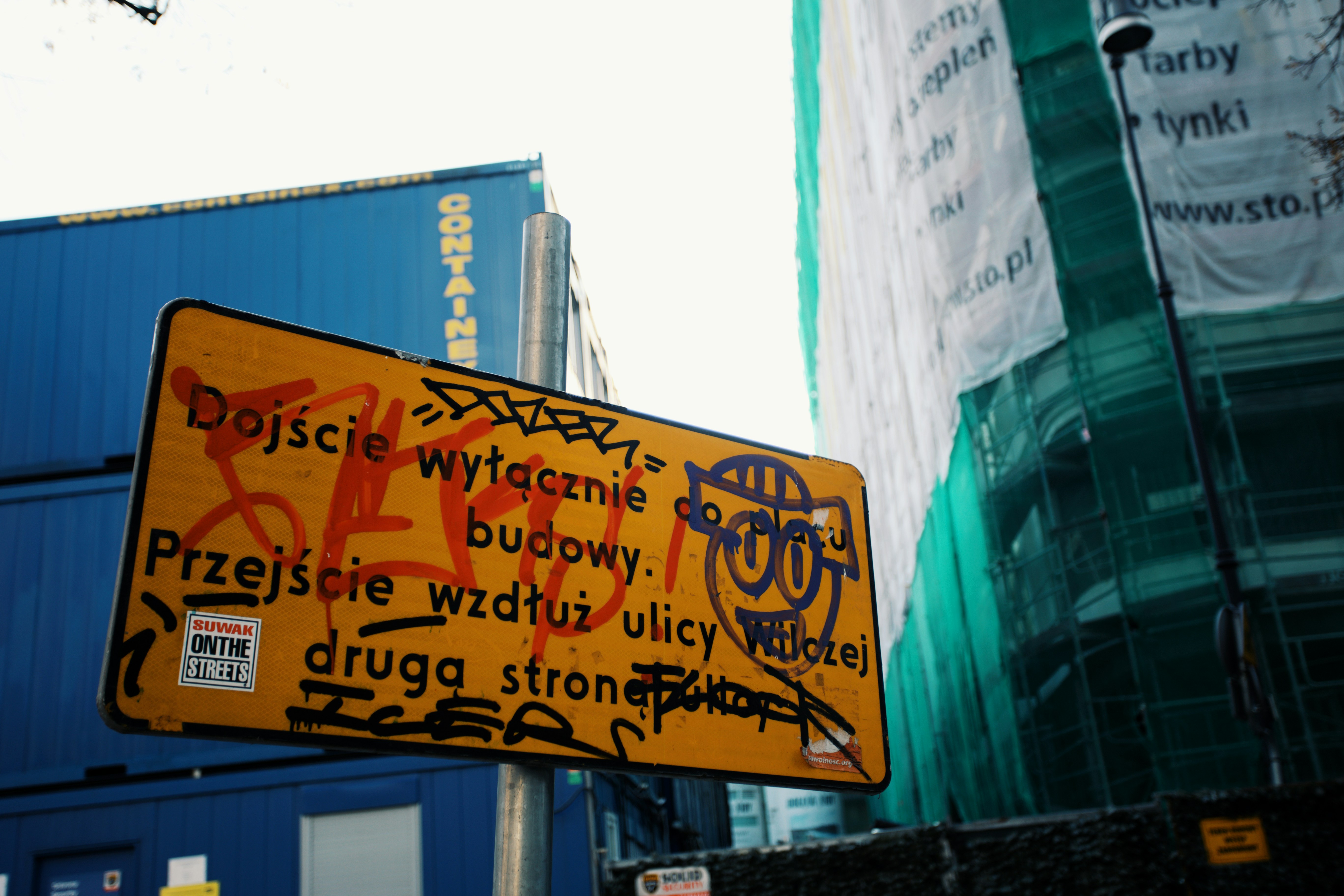 Graffiti-rendered Construction Warning Sign in an Urban Yard