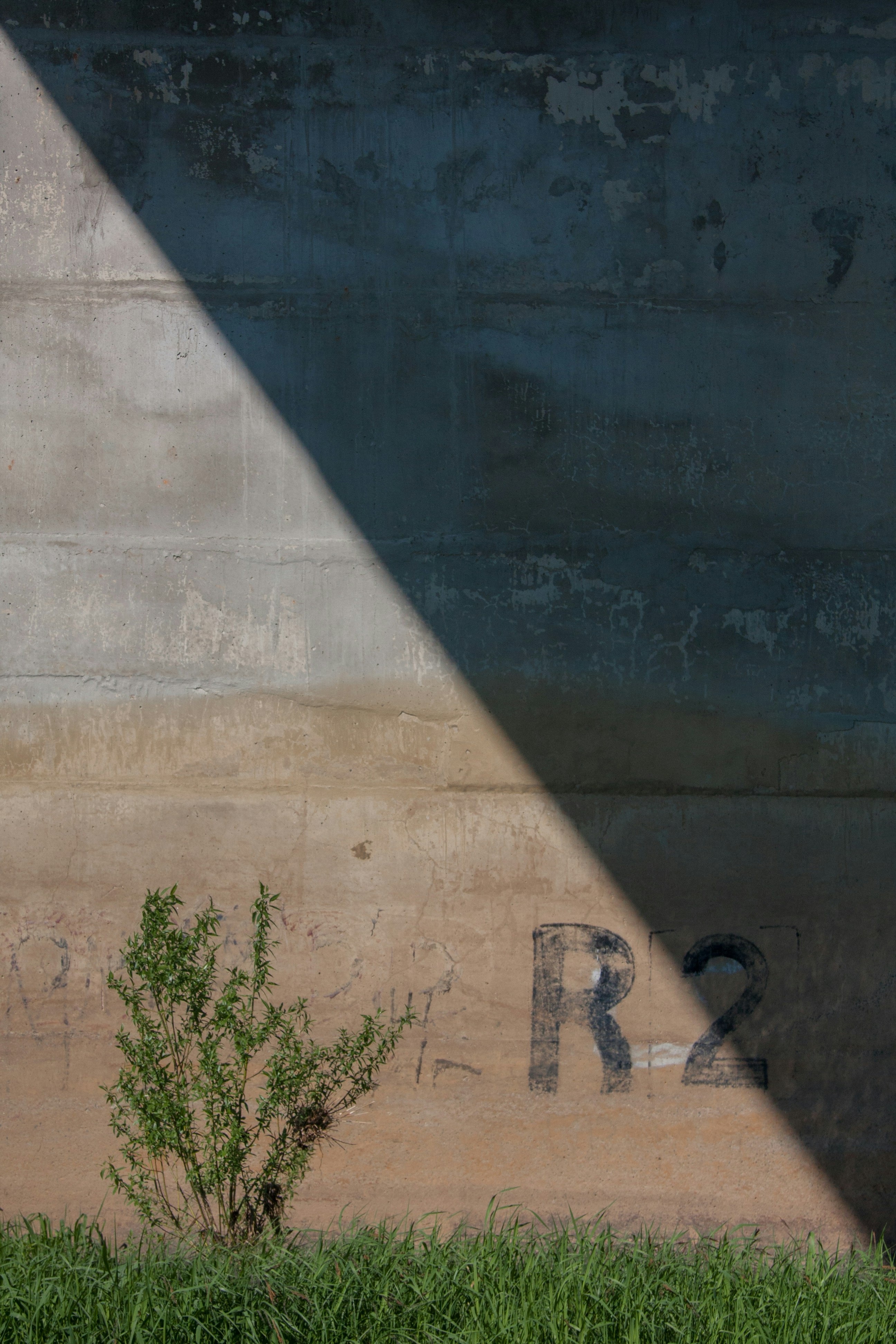 Shadowed Triangle Across a Weathered Wall