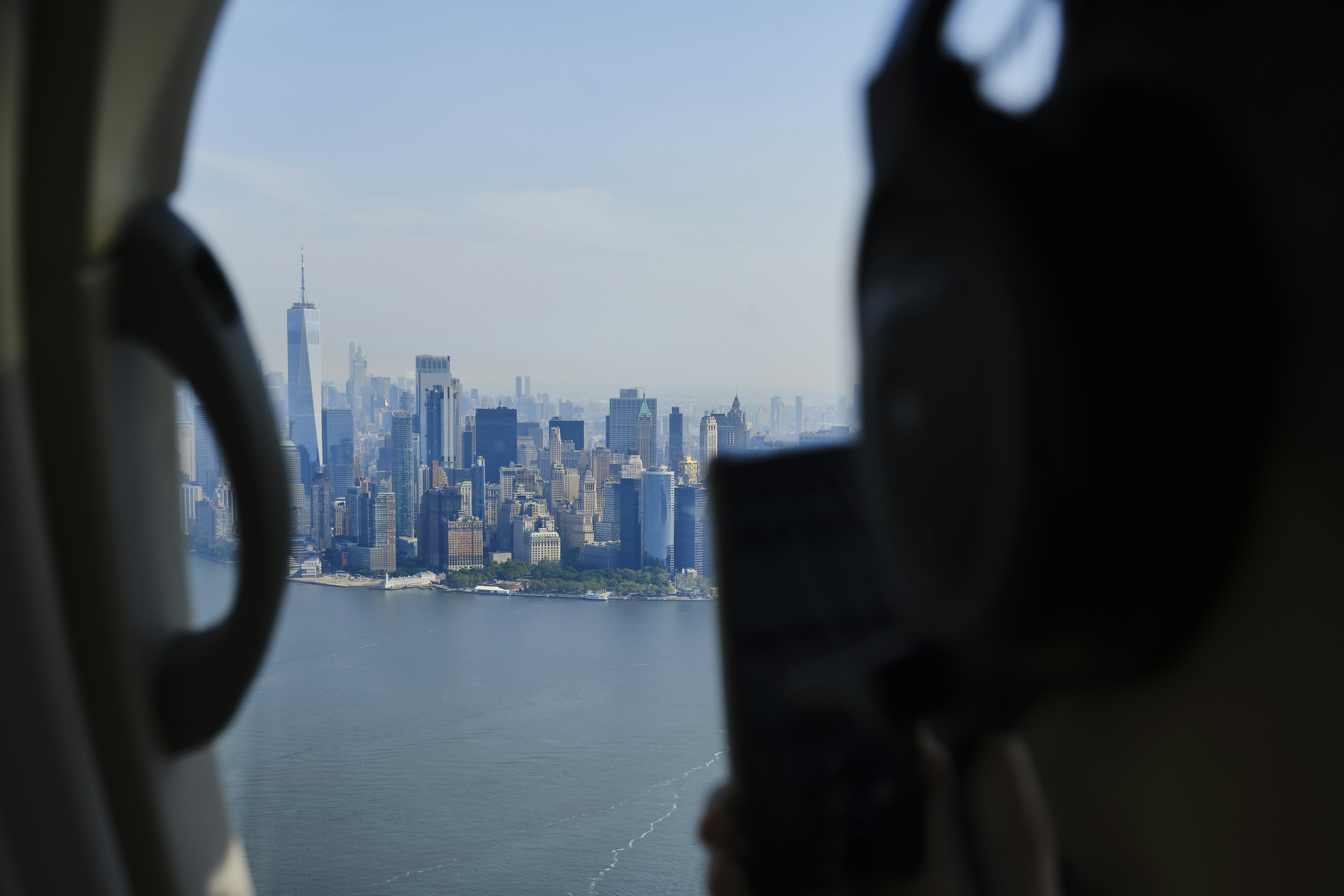 Cityscape through a cabin window: distant skyline framed by blurred foreground