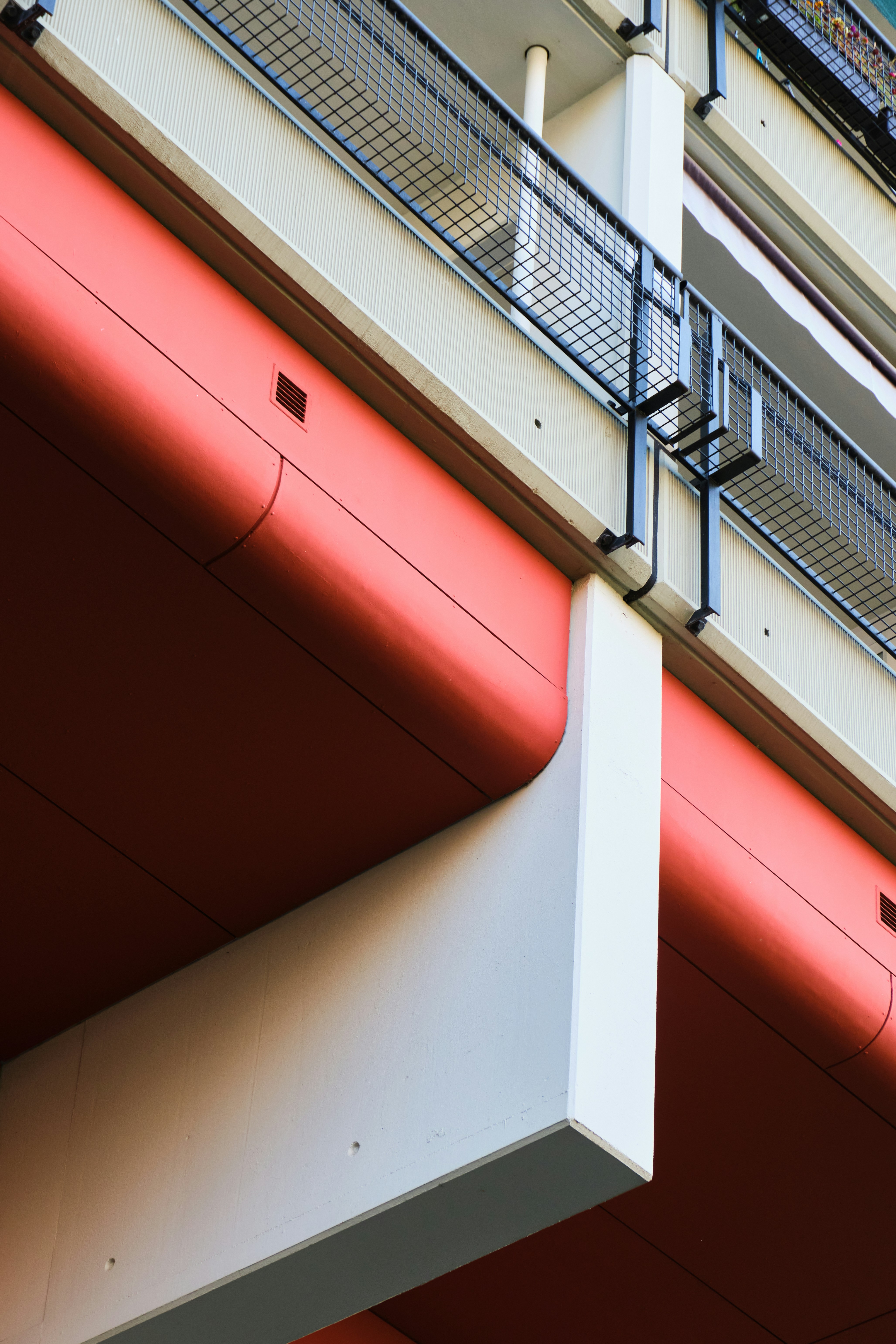 Bold Red Overhang meets Steel Grid: Architectural Geometry in Motion