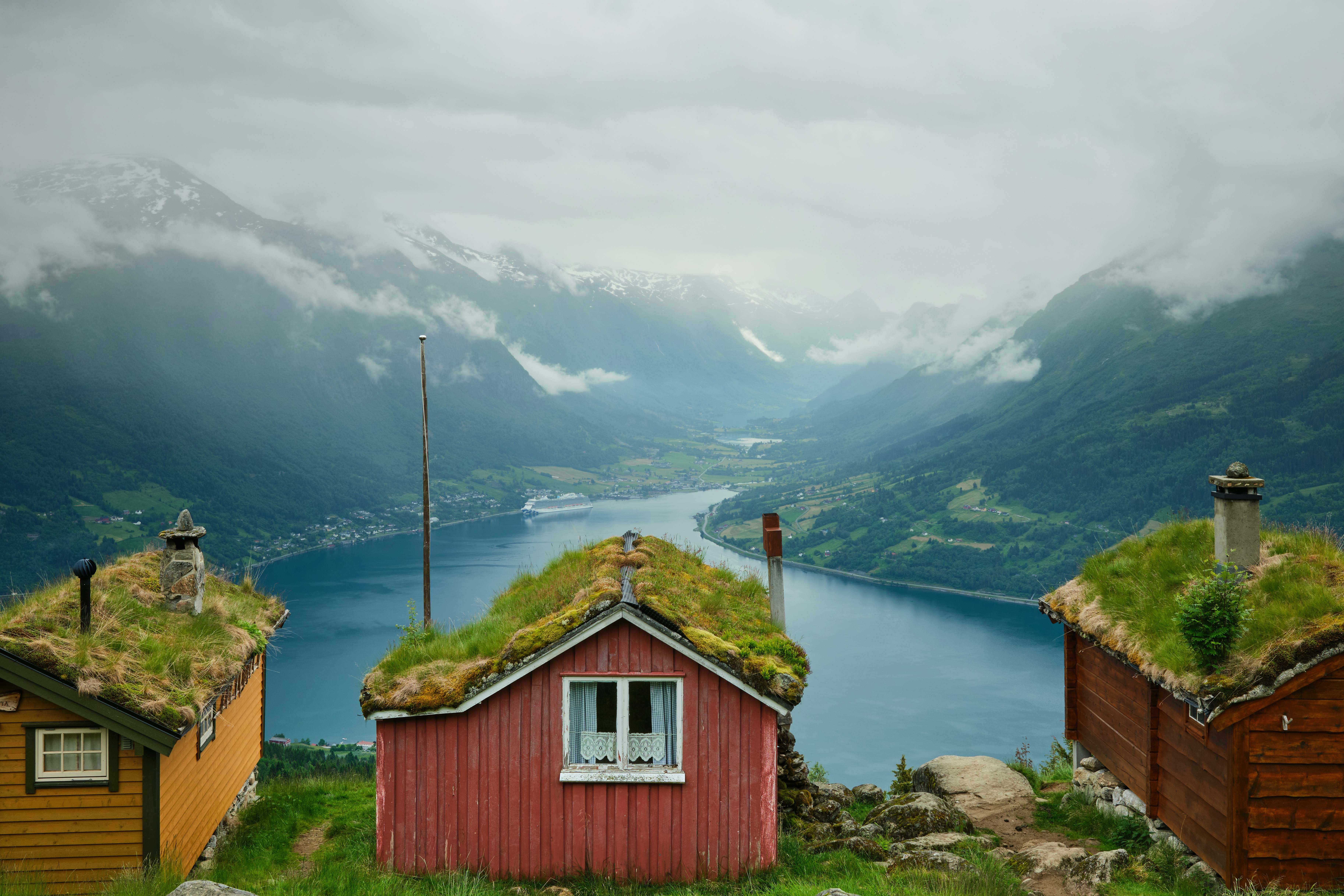 Colorful Grouper Cabins Framing a Fjord Vista