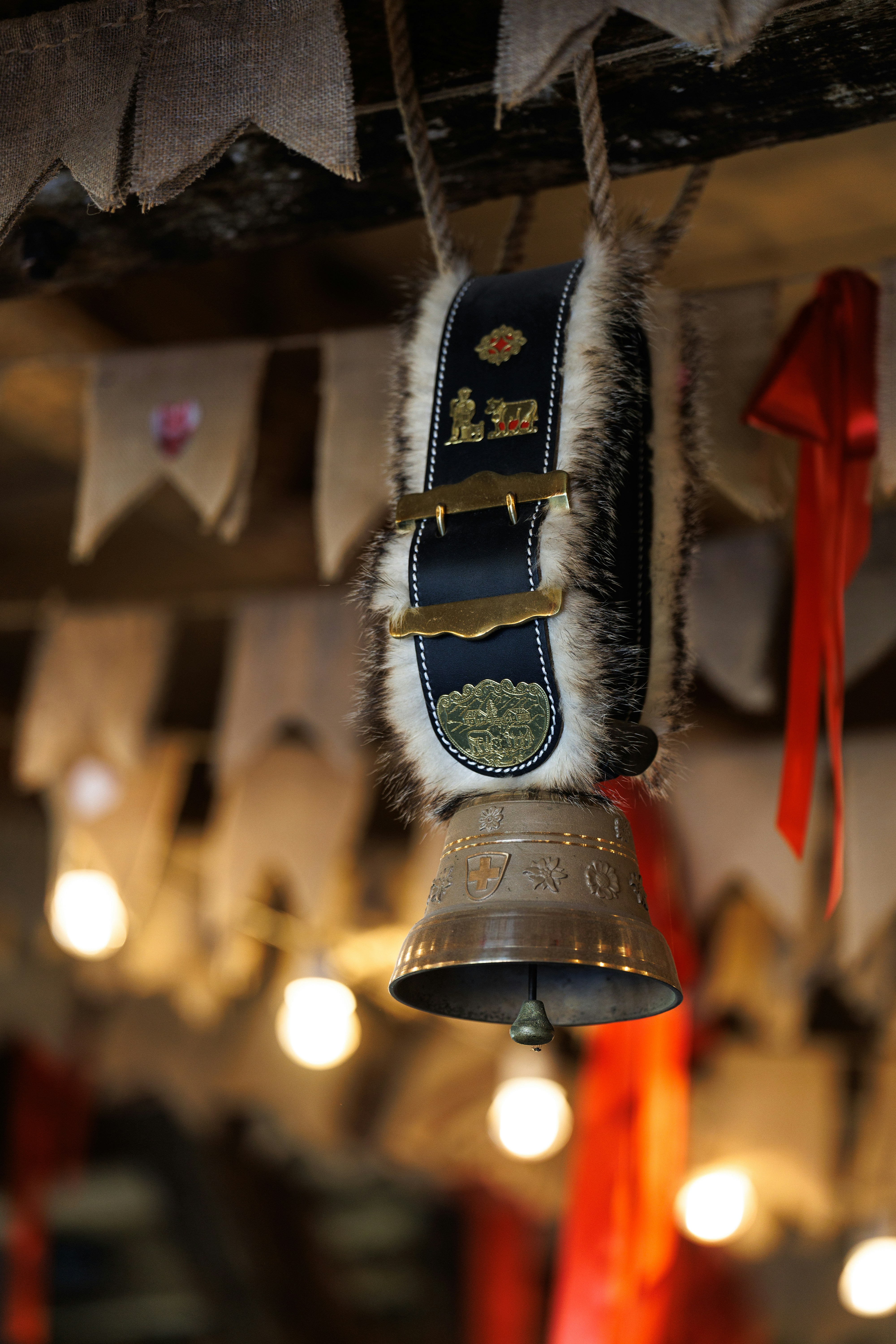 Ringing Heritage: A Furtrimmed Bell with Emblems in a Rustic Interior