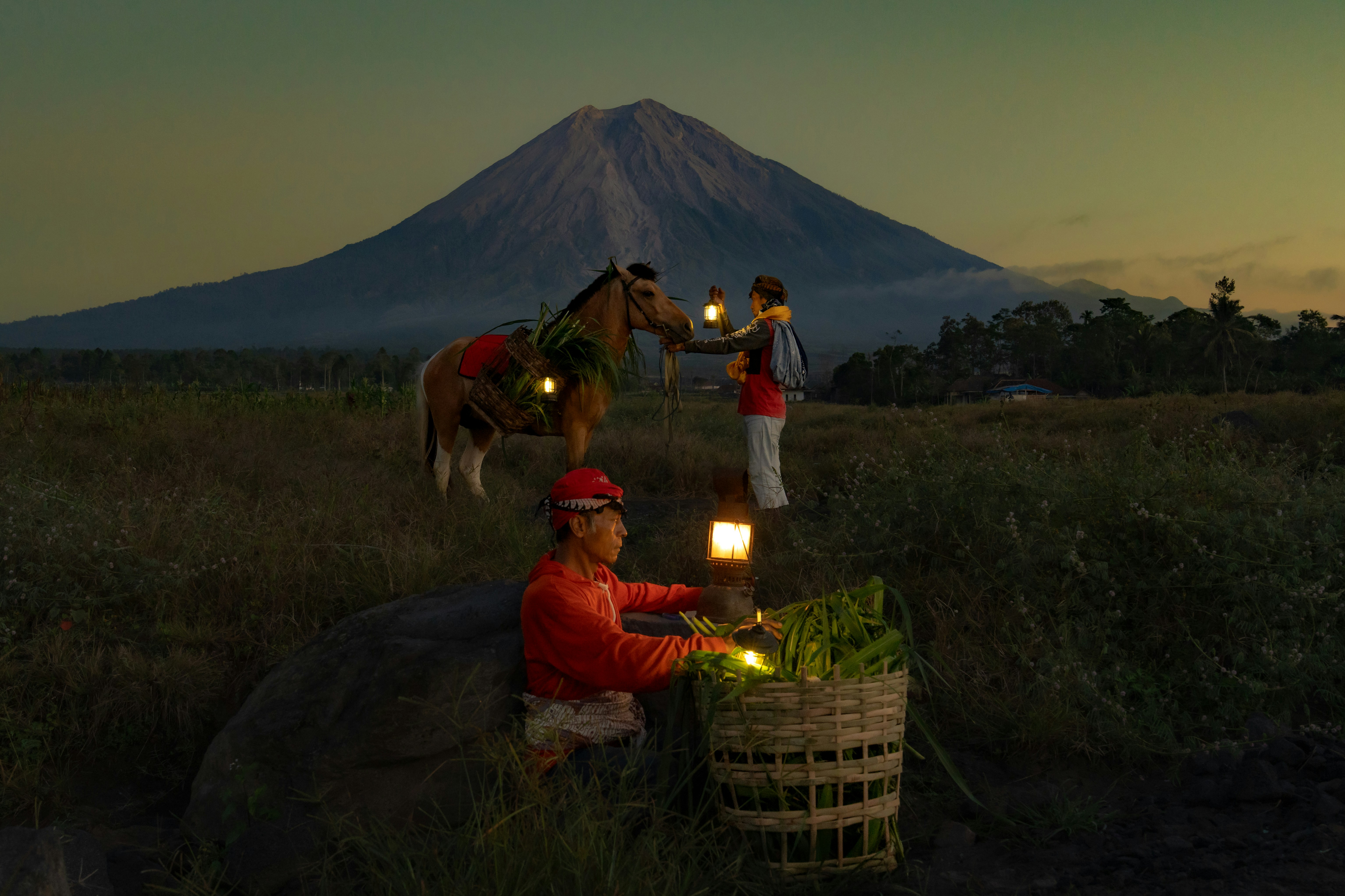 Lanterns at Dusk: A Quiet Field Under a Volcano