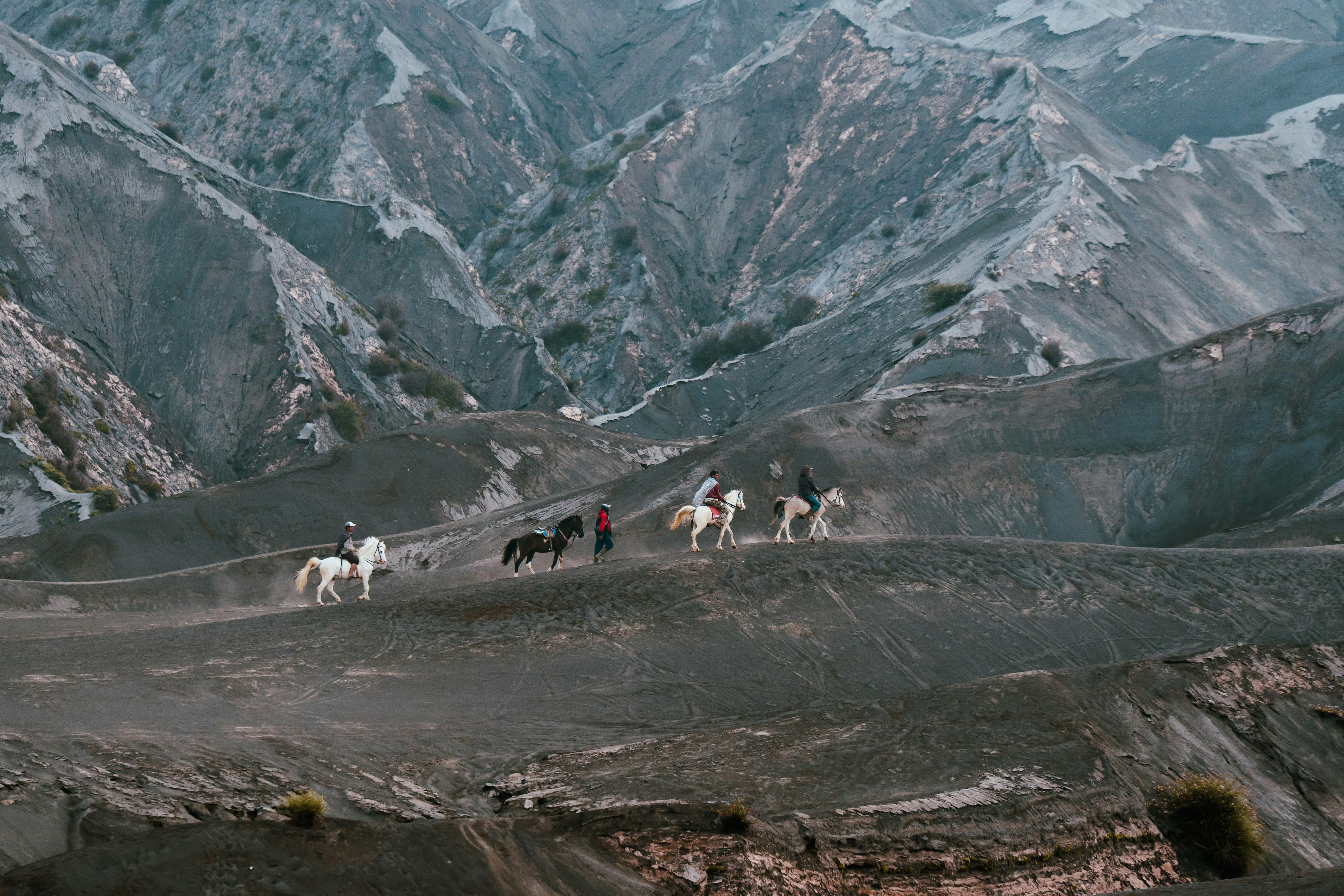 Desert caravan over a desolate mountain ridge