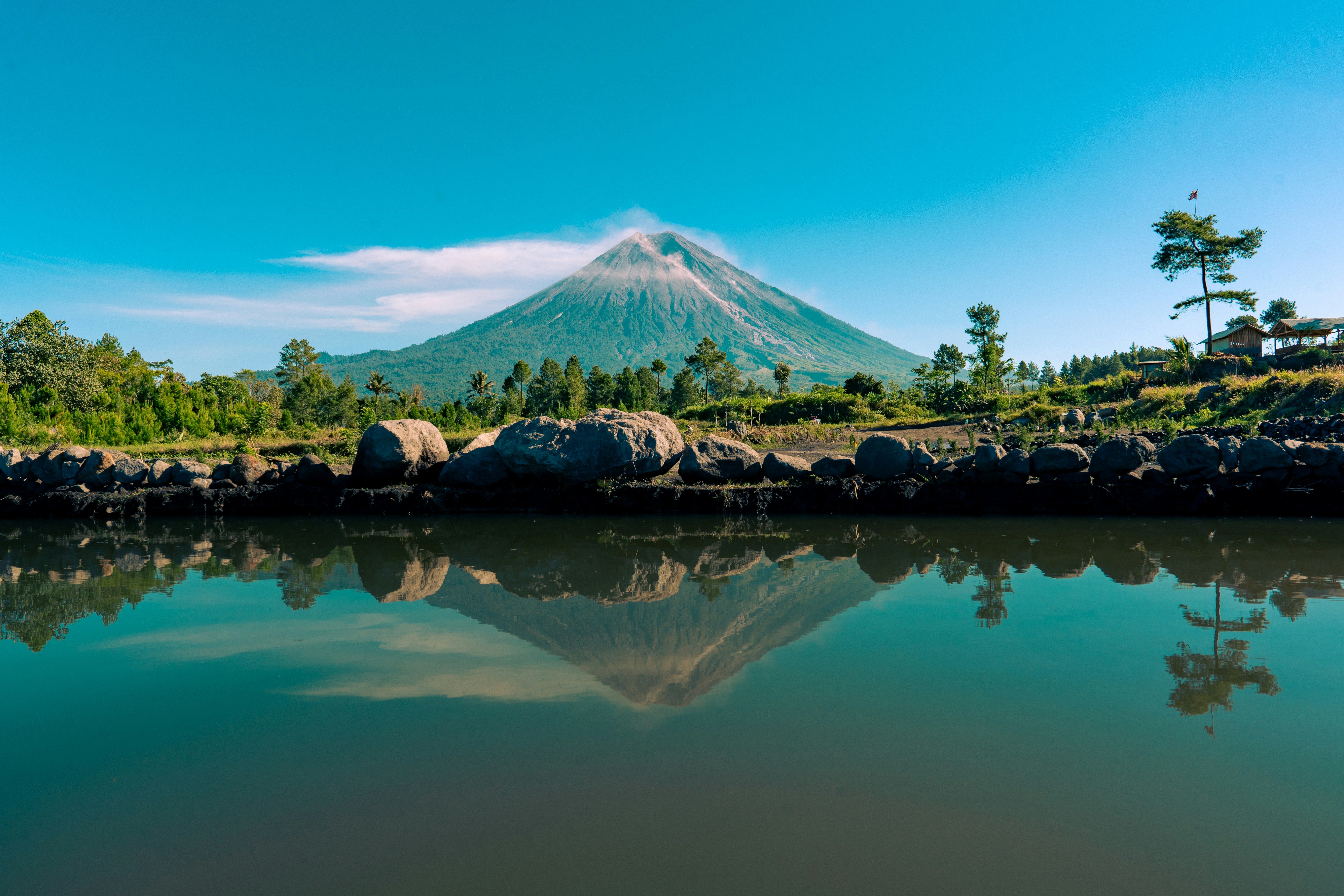 Symmetric Peak: A Volcanic Cone Rising Over a Glassy Lake