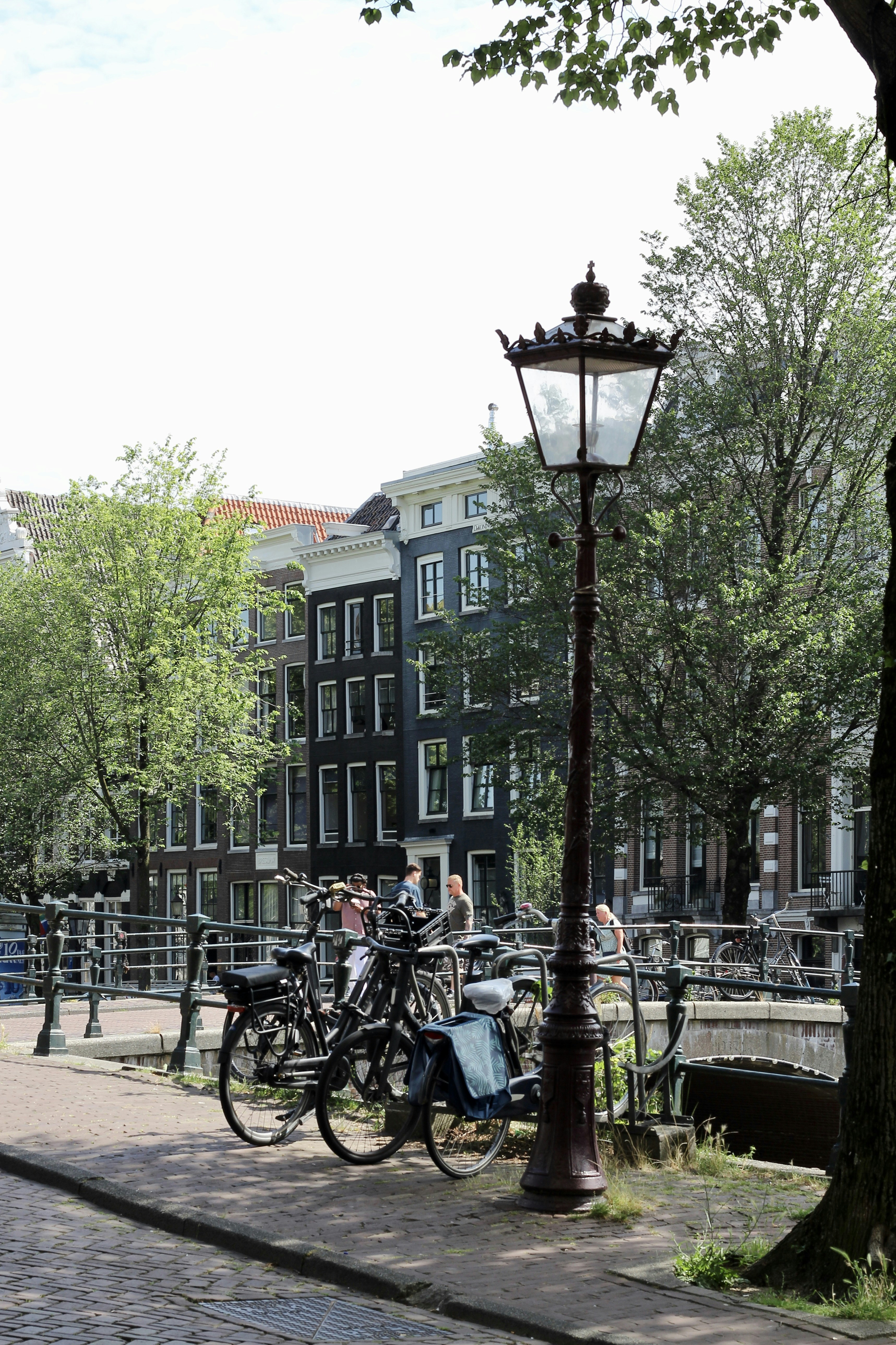 Lantern on the Canal: Bicycles and Dutch Facades in Spring Light