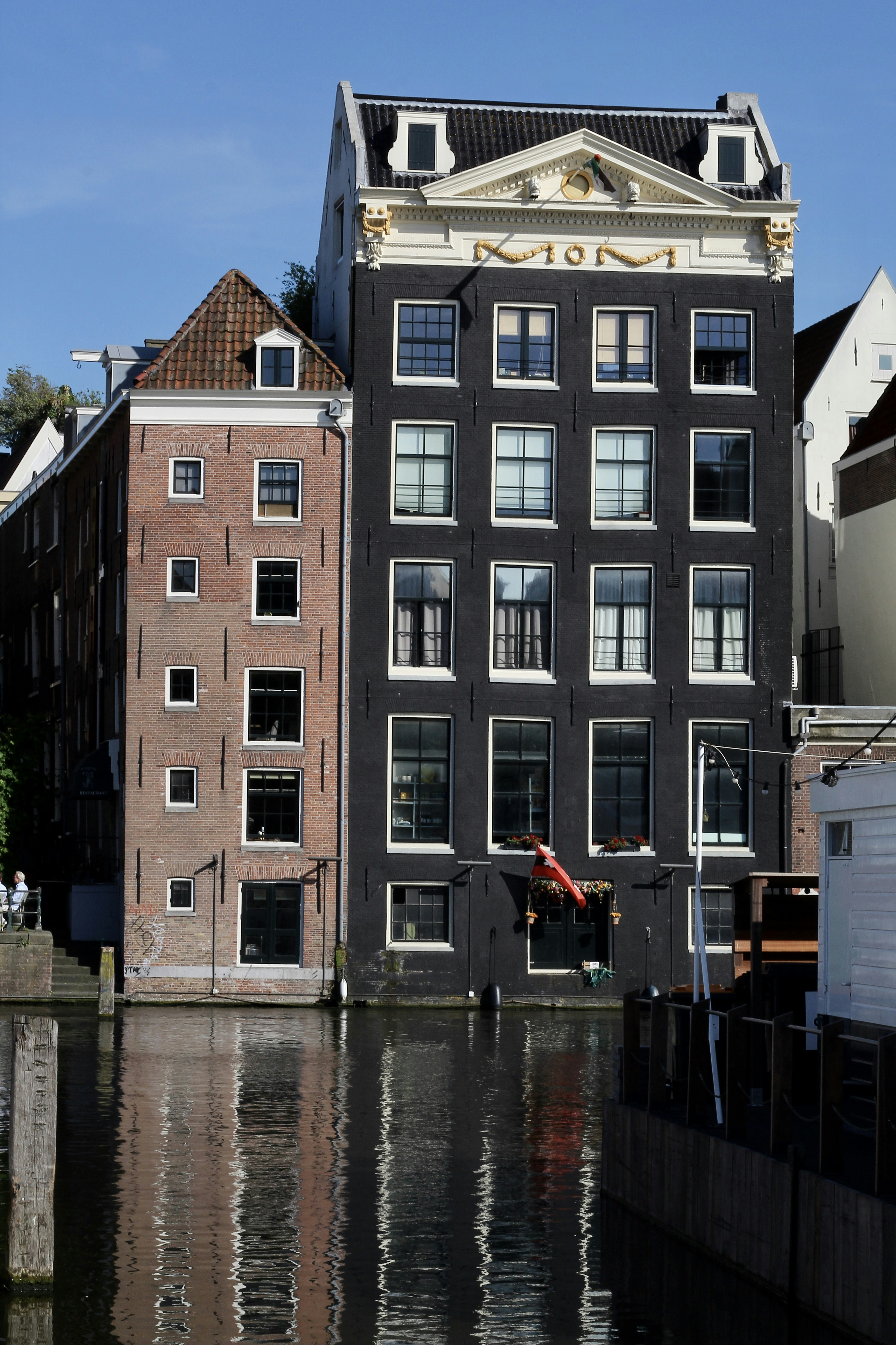Canal Facade: A Row of Historic Townhouses Reflected in Still Water