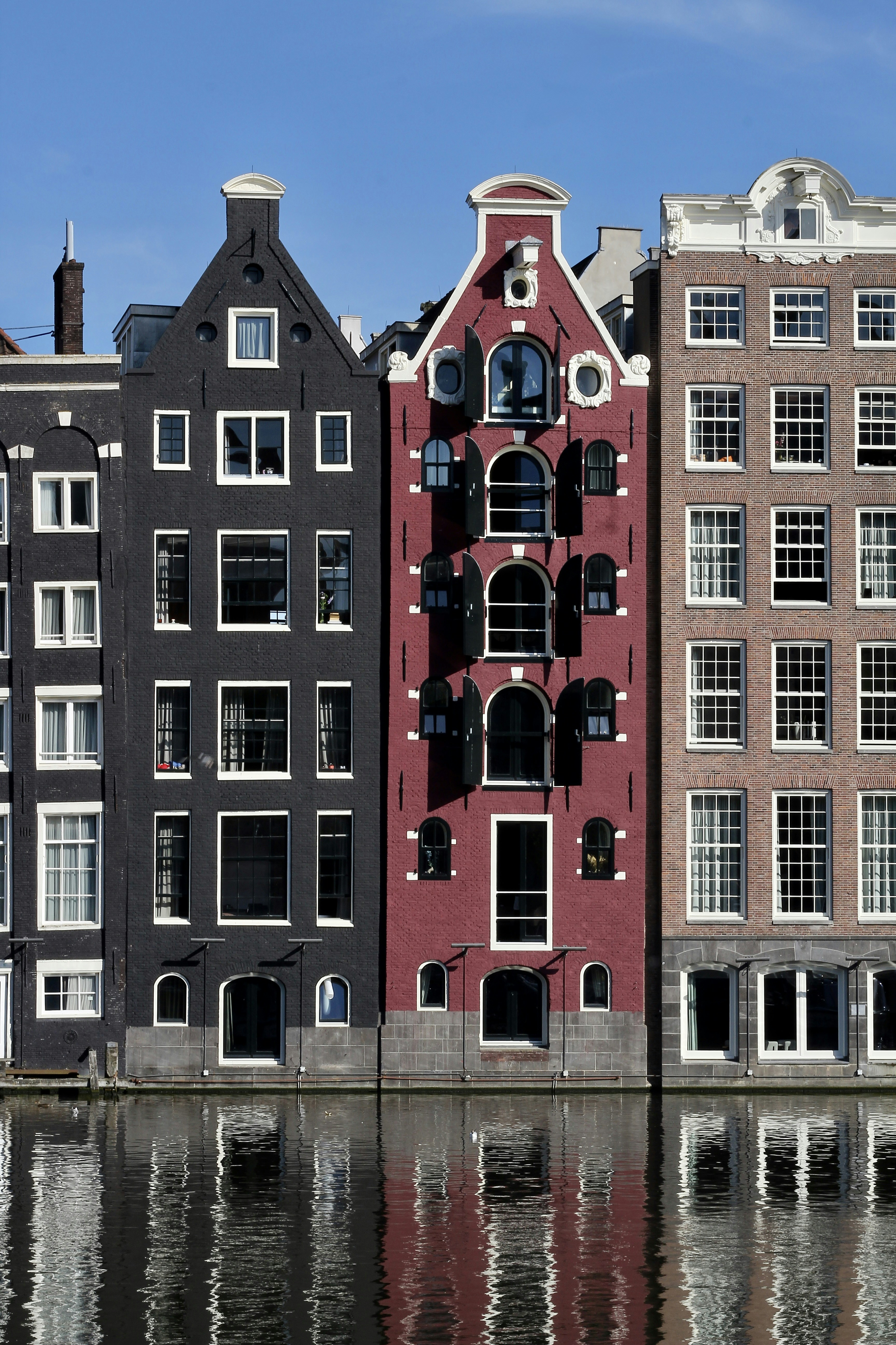 Harbor-row Architecture: A Red House Among Grayscale Facades