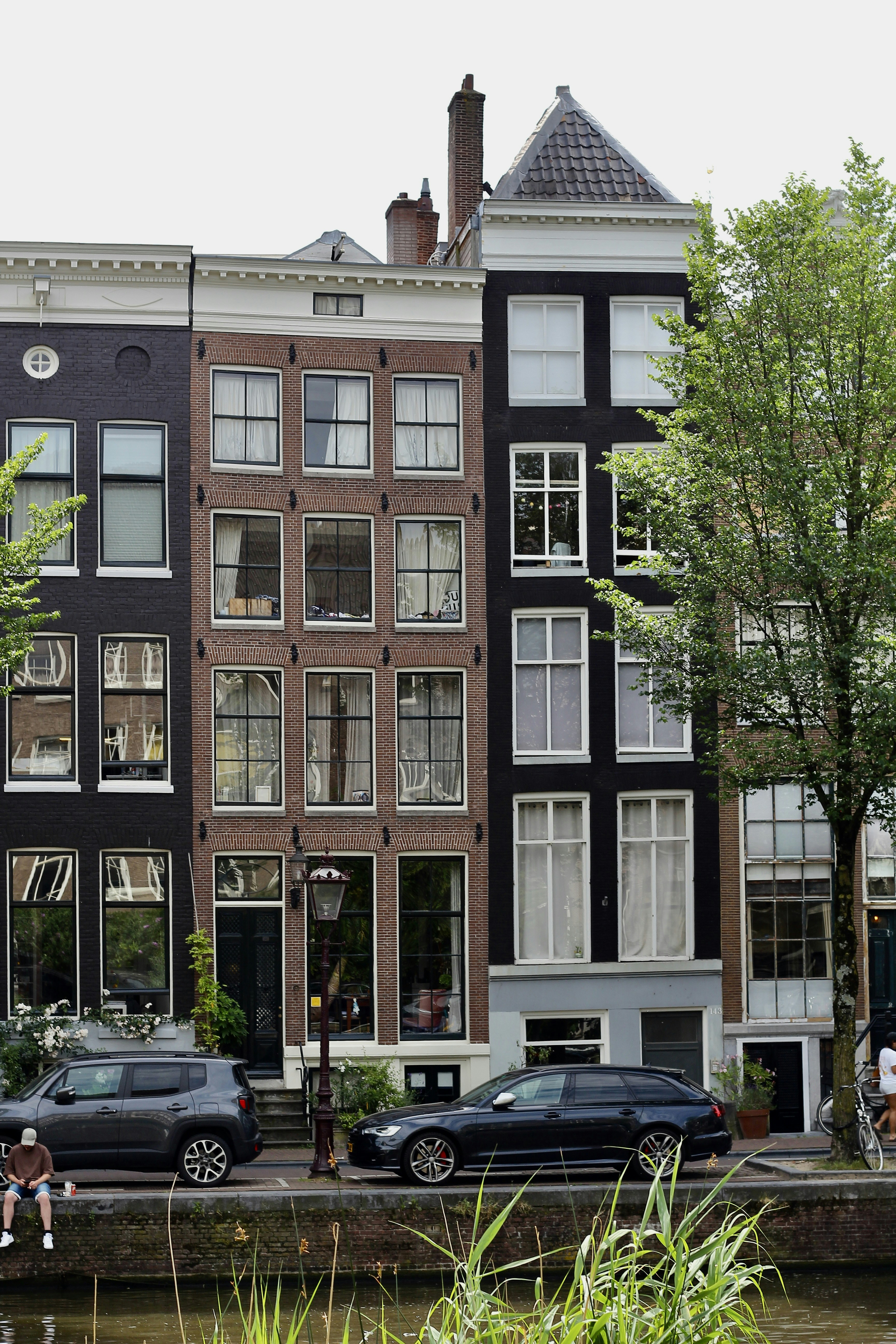 Row of Dutch Canal Houses Reflected in Urban Stillness