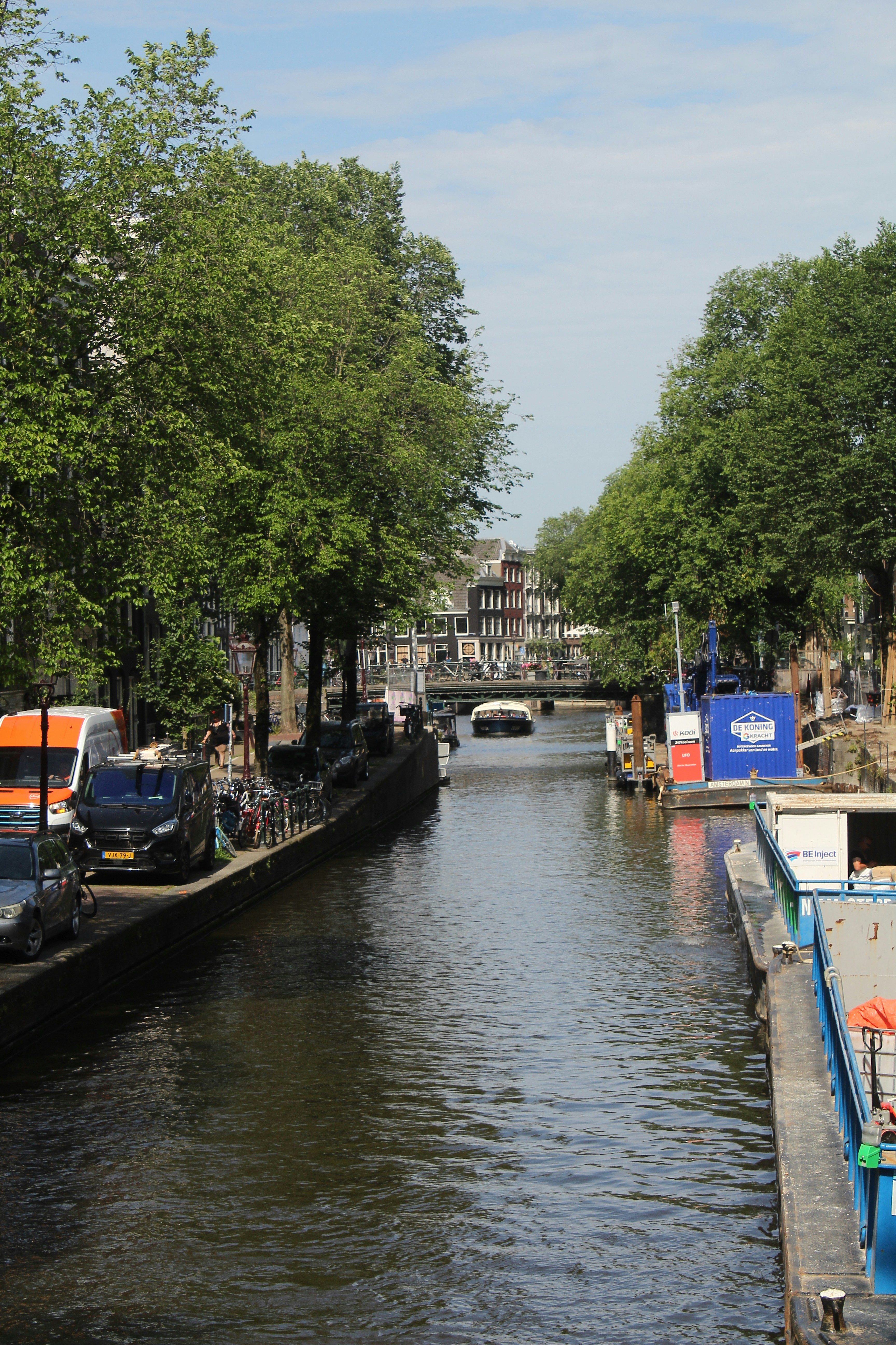 Canal of Quiet Motion: A Dutch City Channel Framed by Tree-Lined Edges