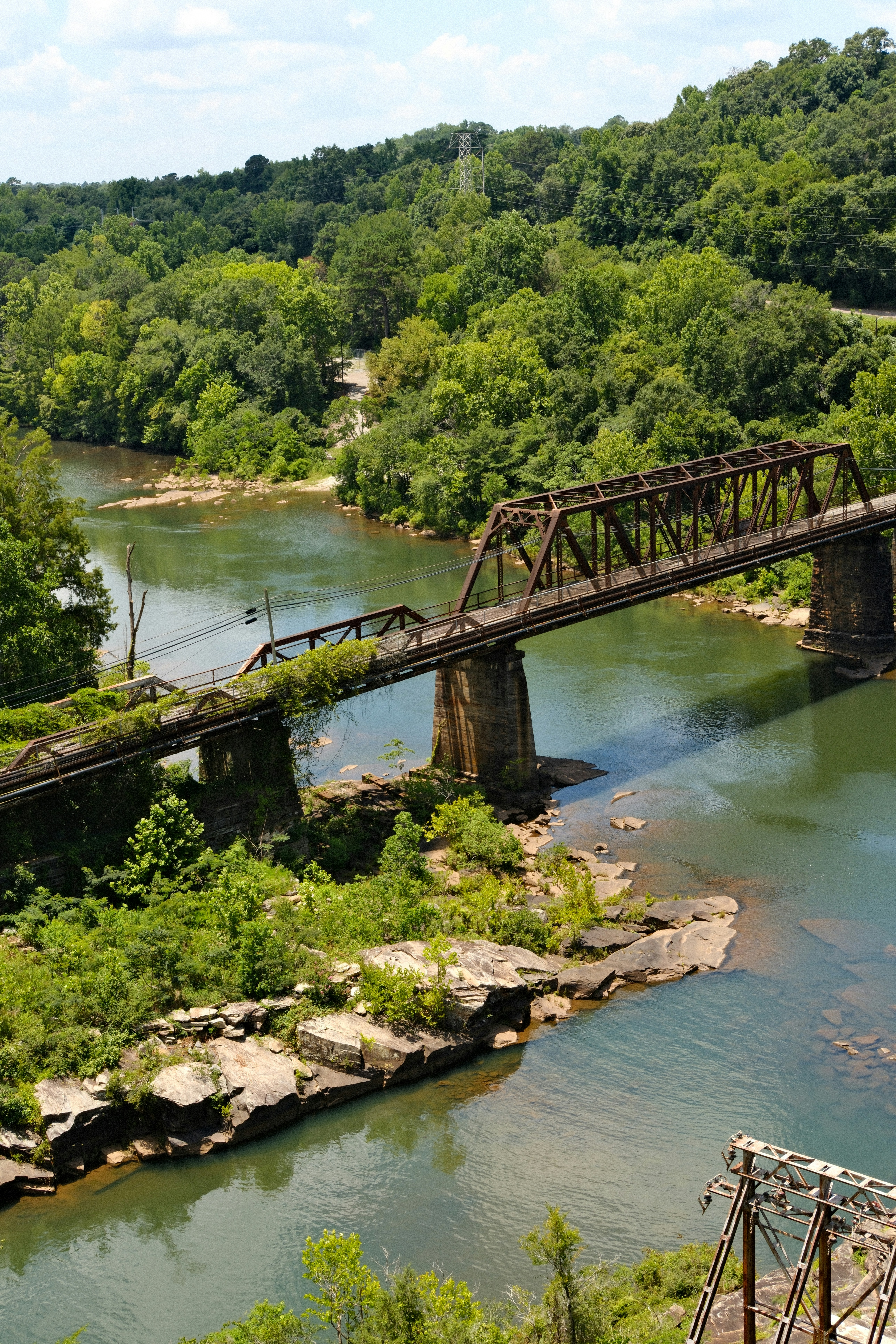 Rust and River: A Rusted Rail Bridge Crossing a Quiet Bend