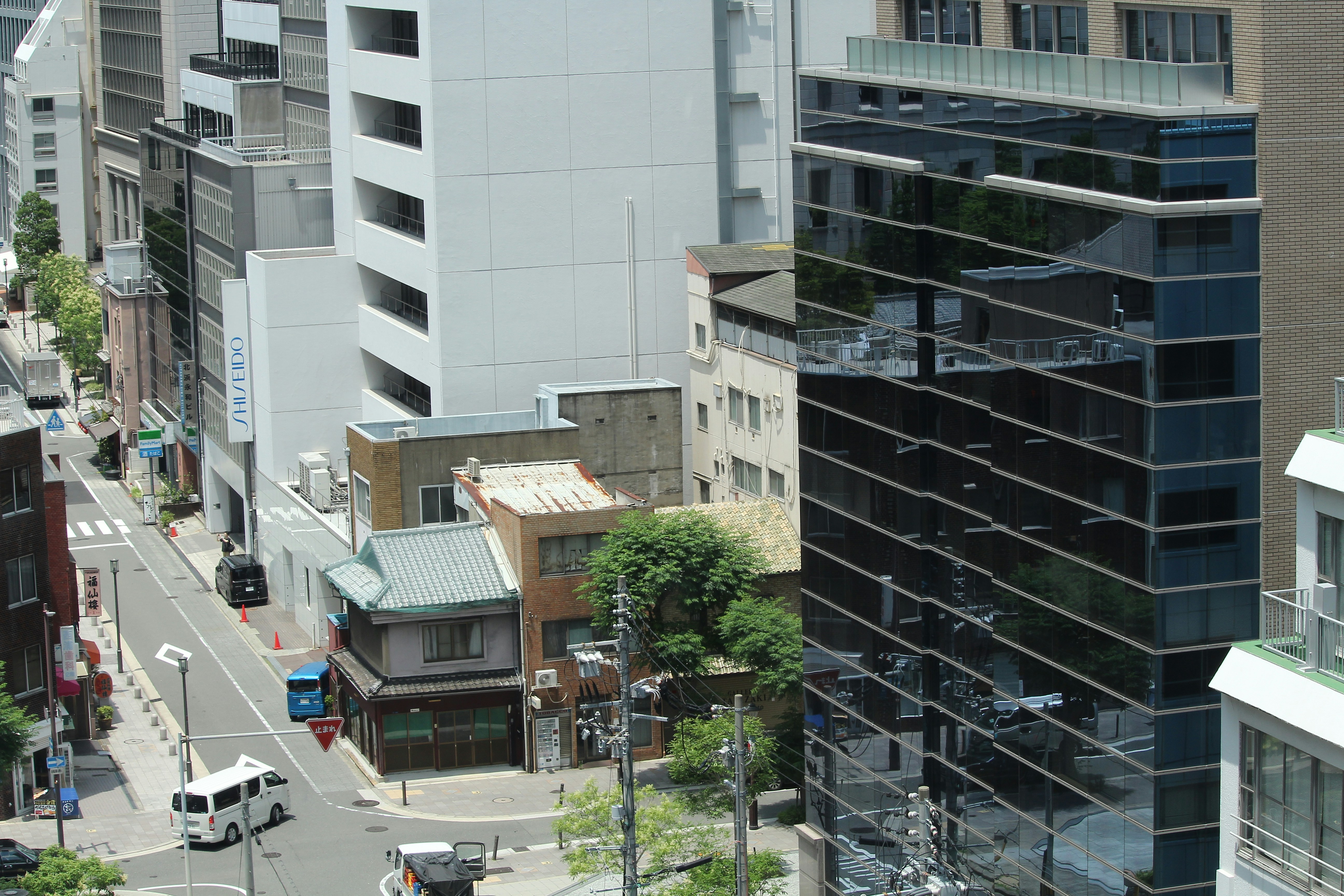 Urban Canyon: Street Level and Glass Facades in a Concrete Block