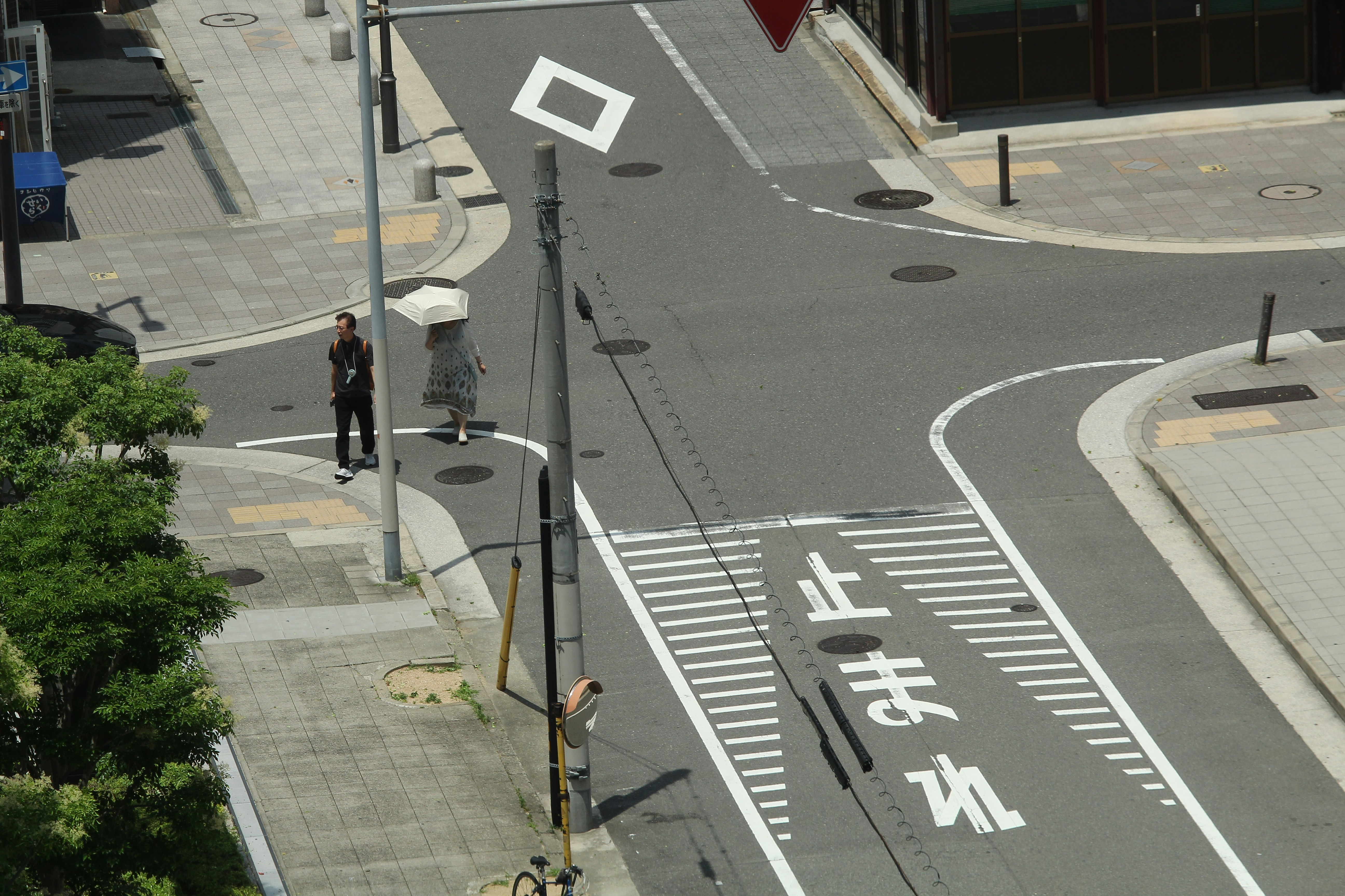 A Quiet Street Crossing: Pedestrians Crossing a Sunlit Intersection