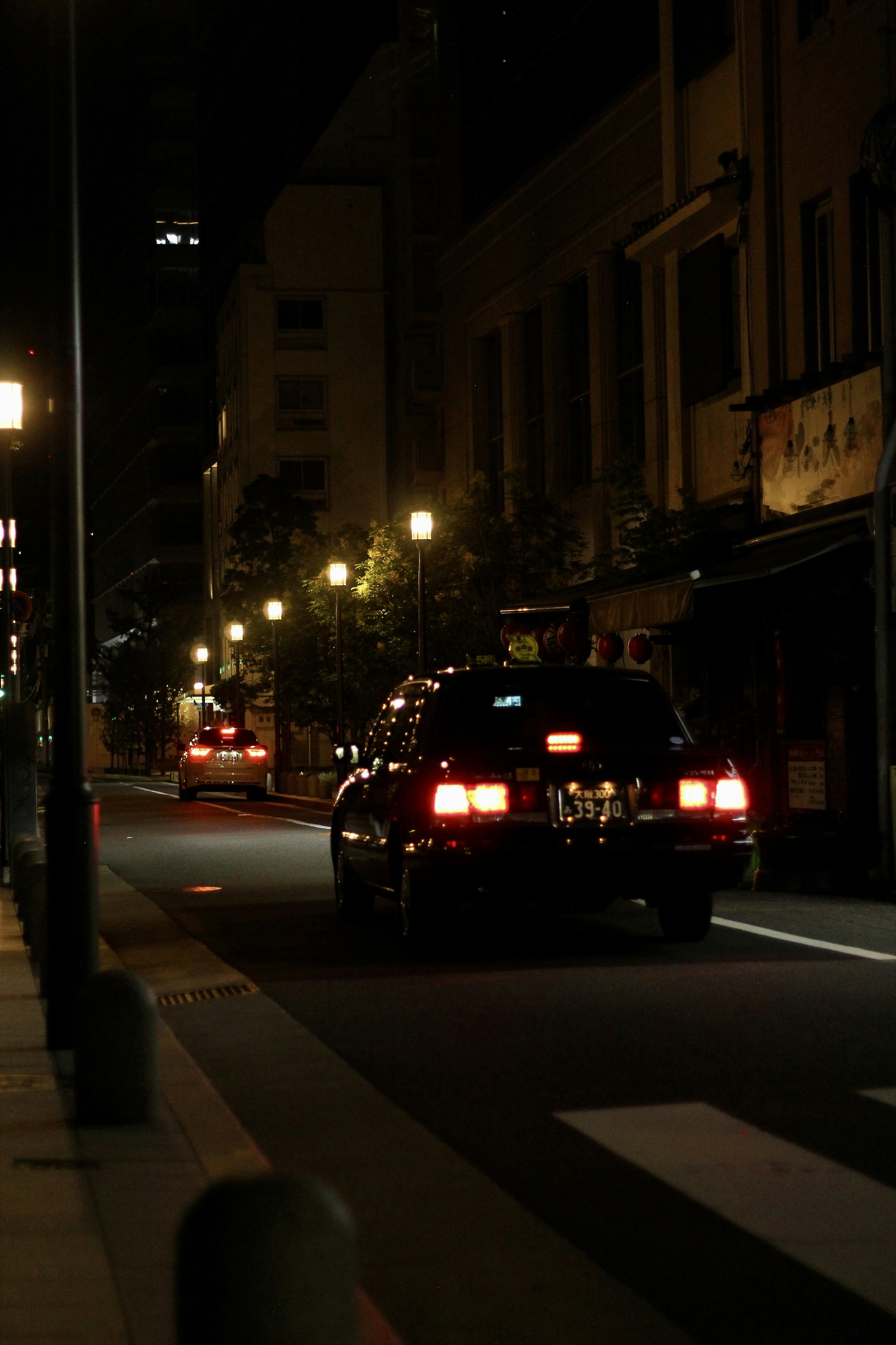 Night Street Pursuit: A City Car Glides Under Warm Neon