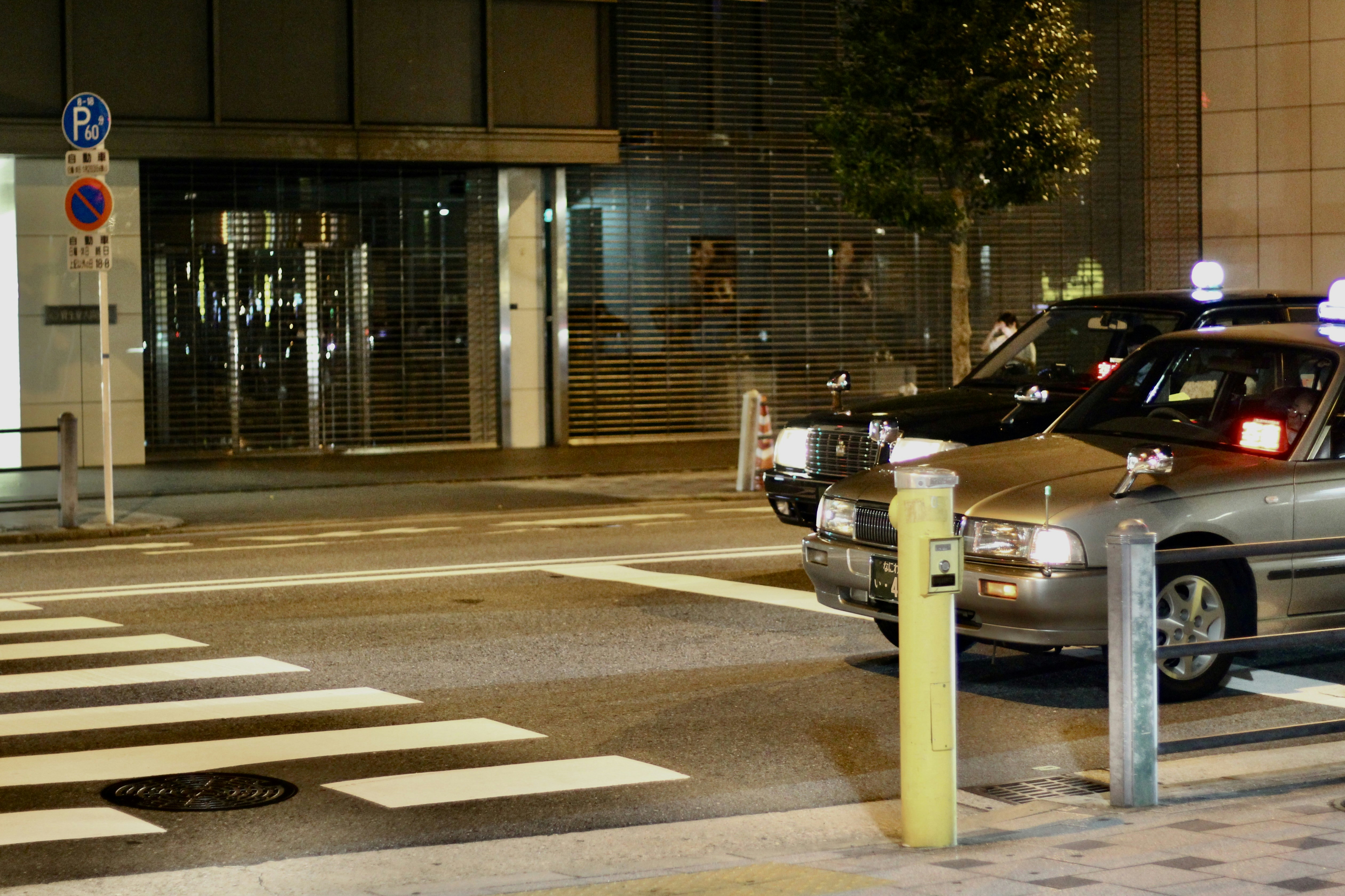 Midnight Crosswalk: A Taxi Standoff at a Quiet City Corner
