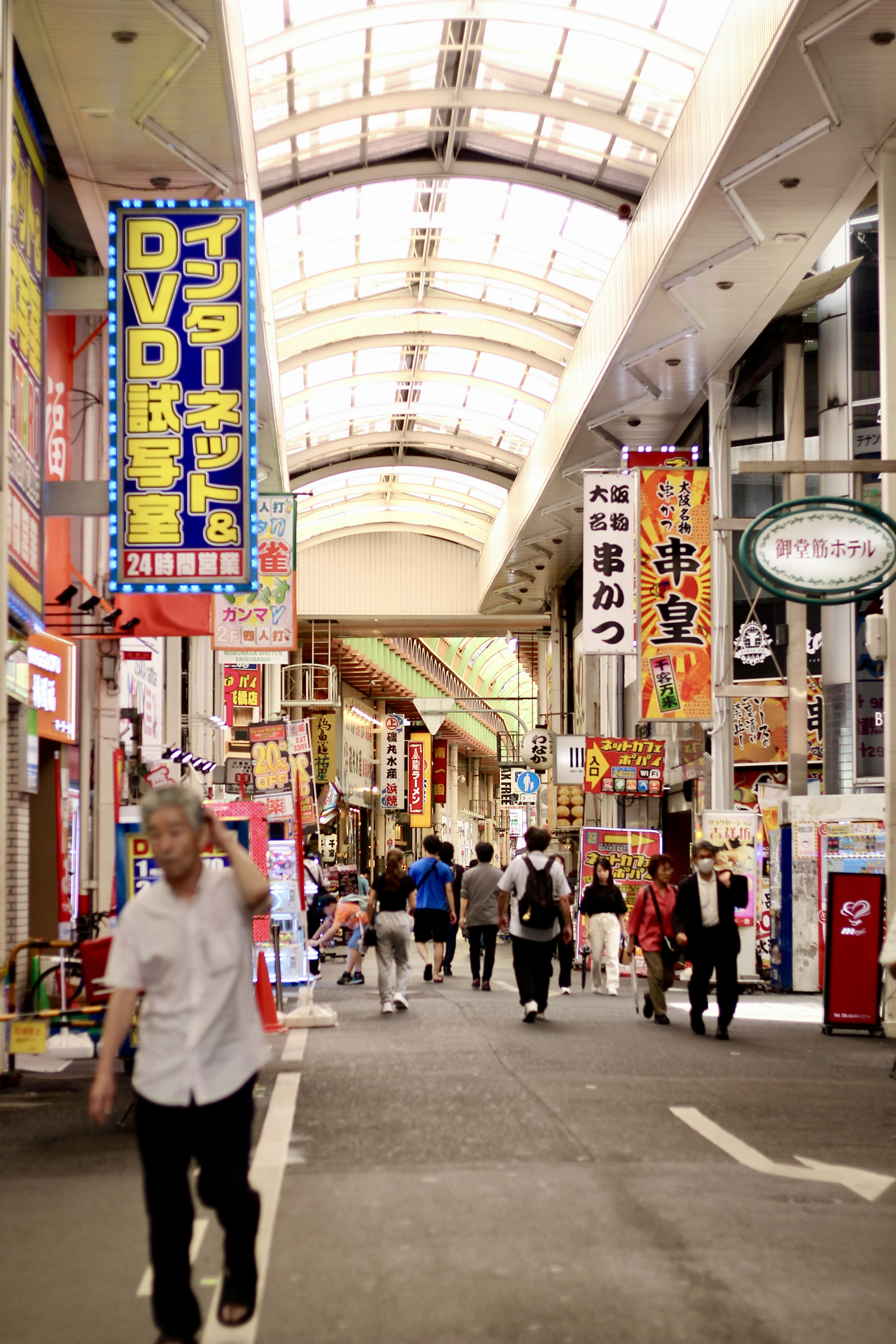 Neon Alley: A Busy Arcade of Colorful Signboards and Pedestrians