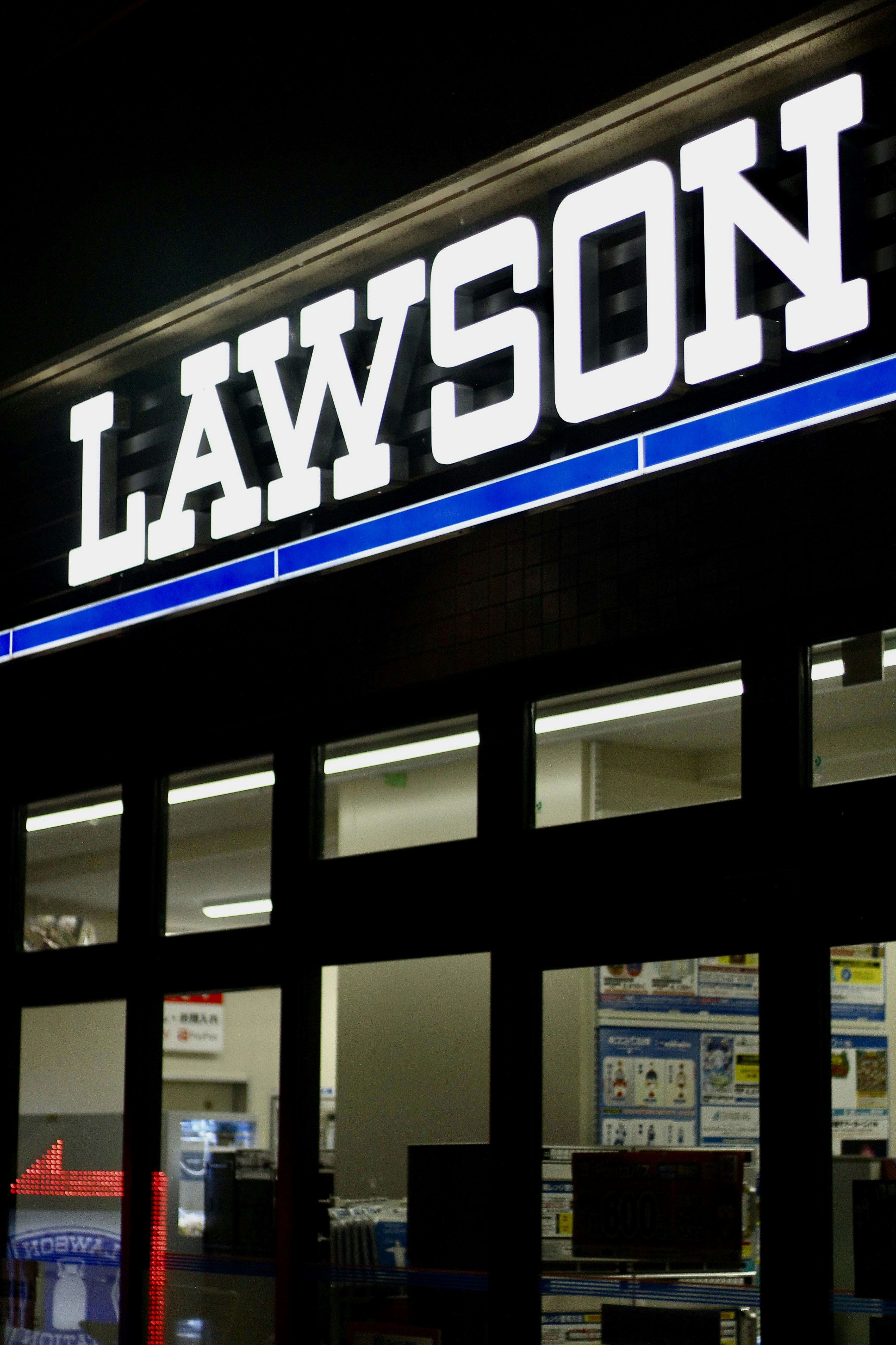Neon Sign at Night: Lawsons illuminated storefront fronts