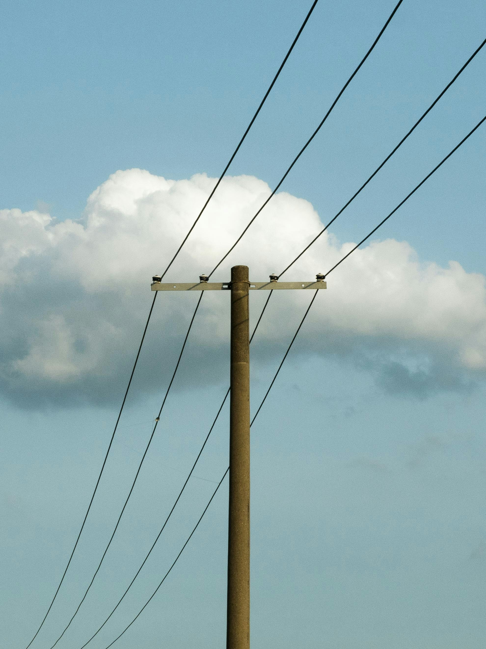 Pole and Wires Under Wide Blue Sky