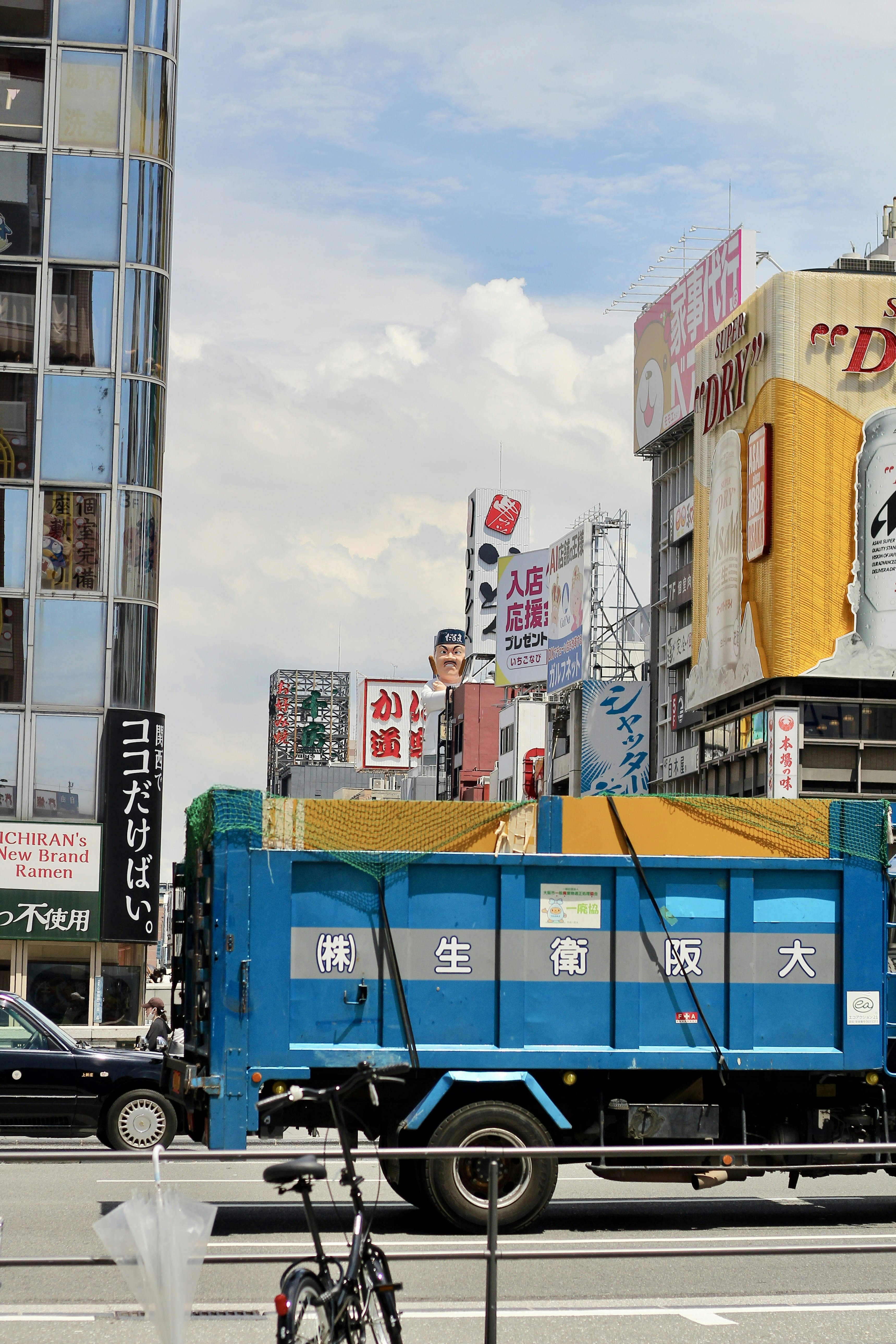 Blue Dump Truck in a Bustling Cityscape