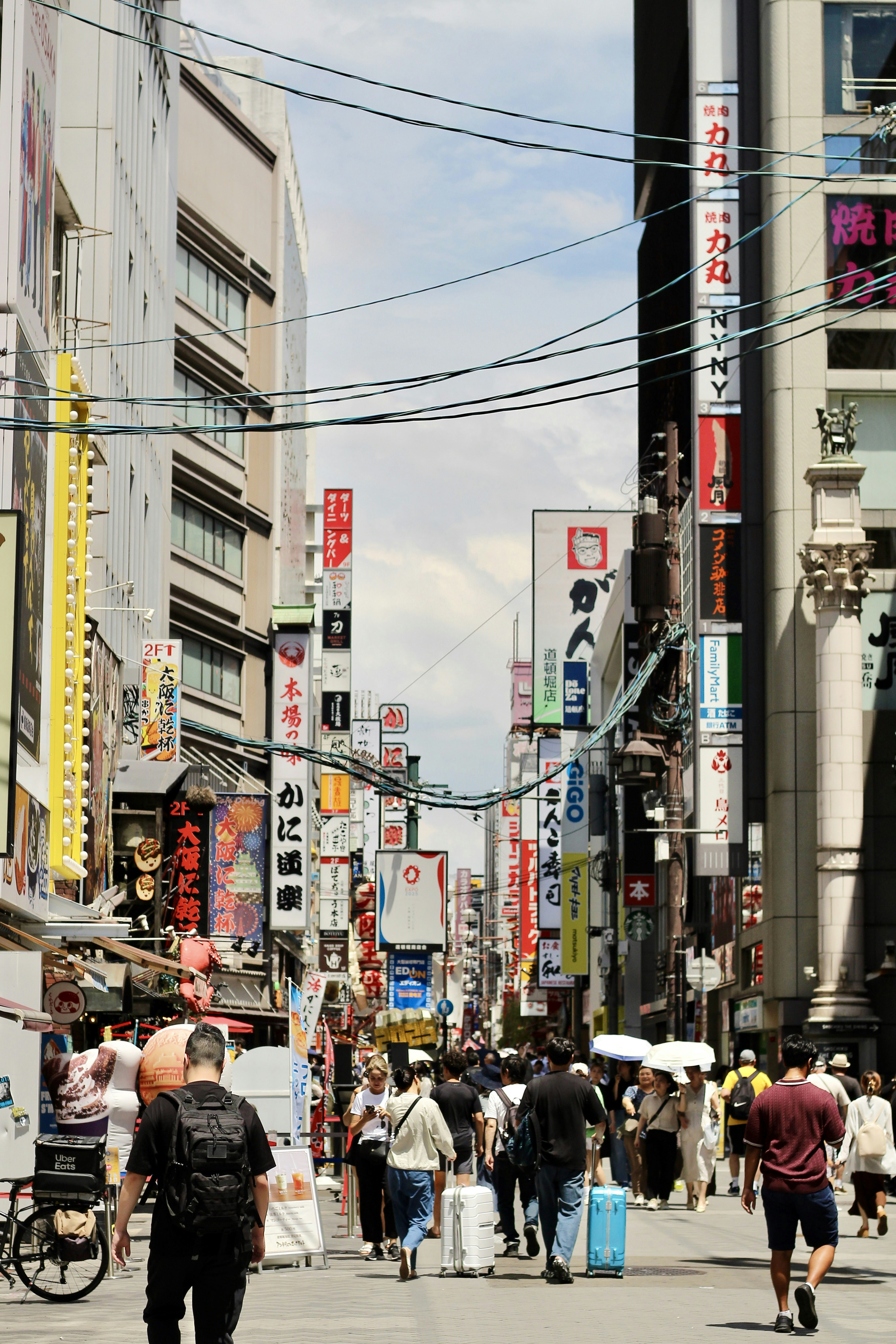 Bustling Shibuya-Style Street: A Corridor of Colorful Signage and Pedestrian Motion