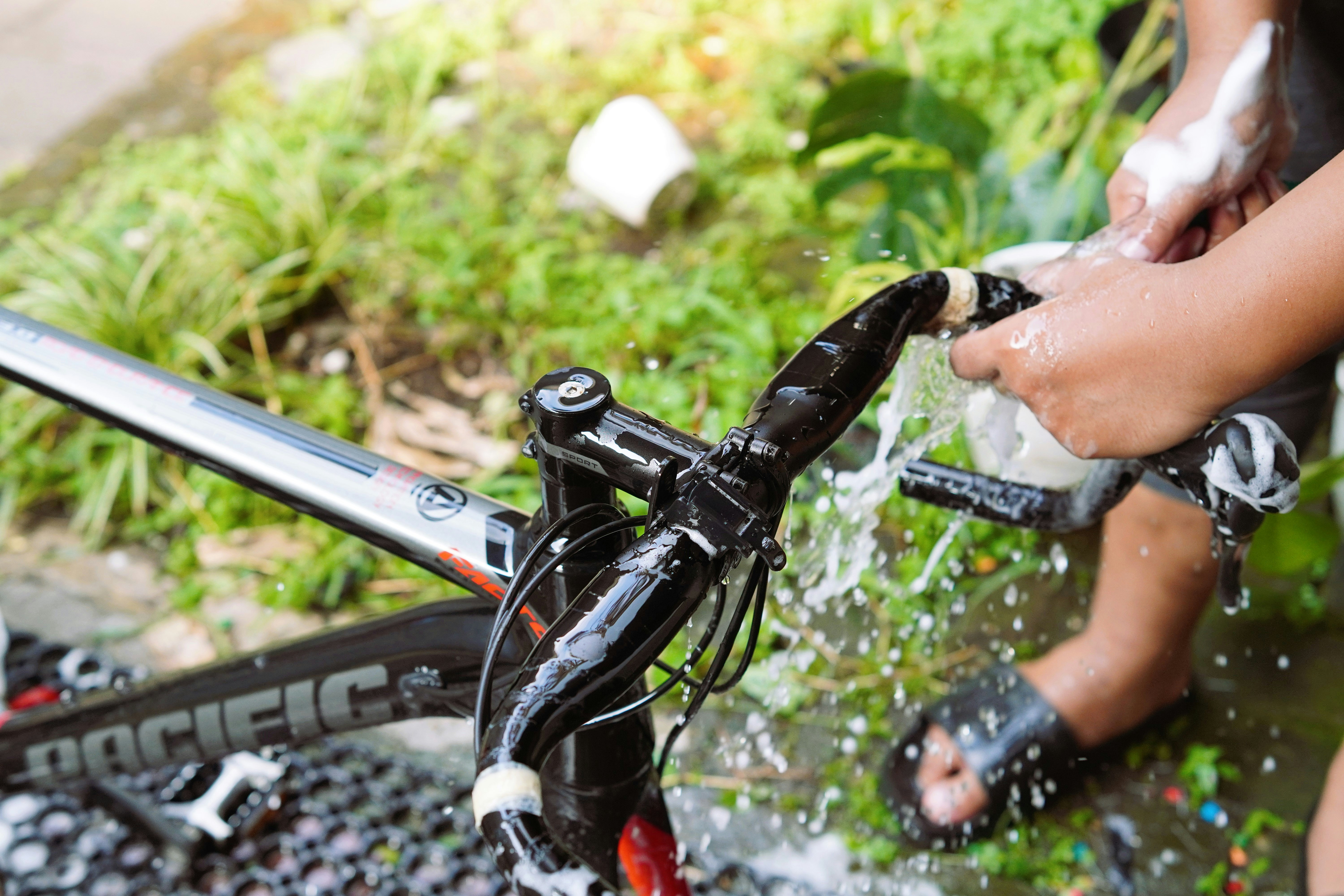 Washing Away Dirt: A Mountain Bike Getting Soaked at the Tap