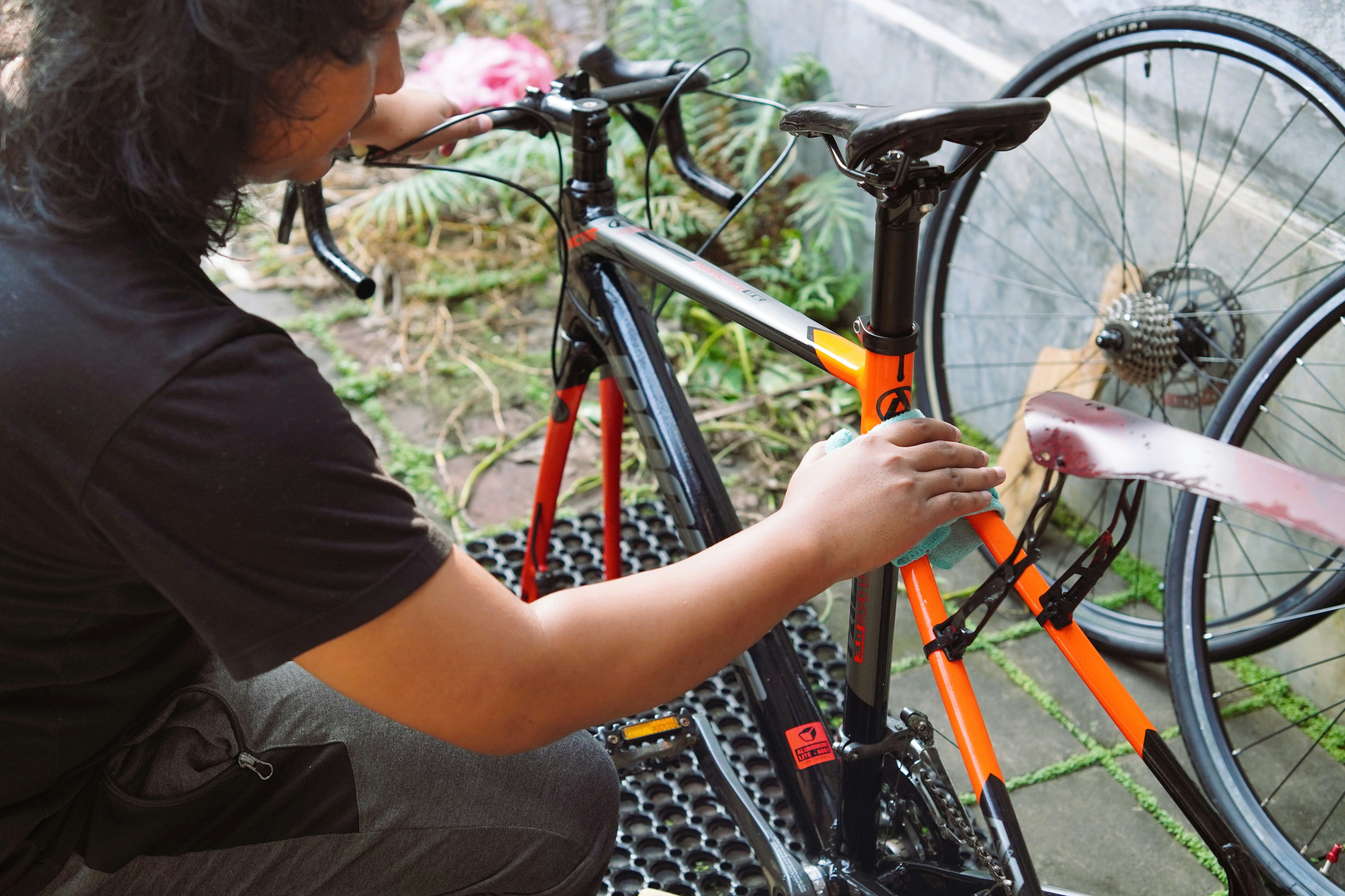 Hands at Work: A Mechanic Repairing a Neon-Accented Bicycle
