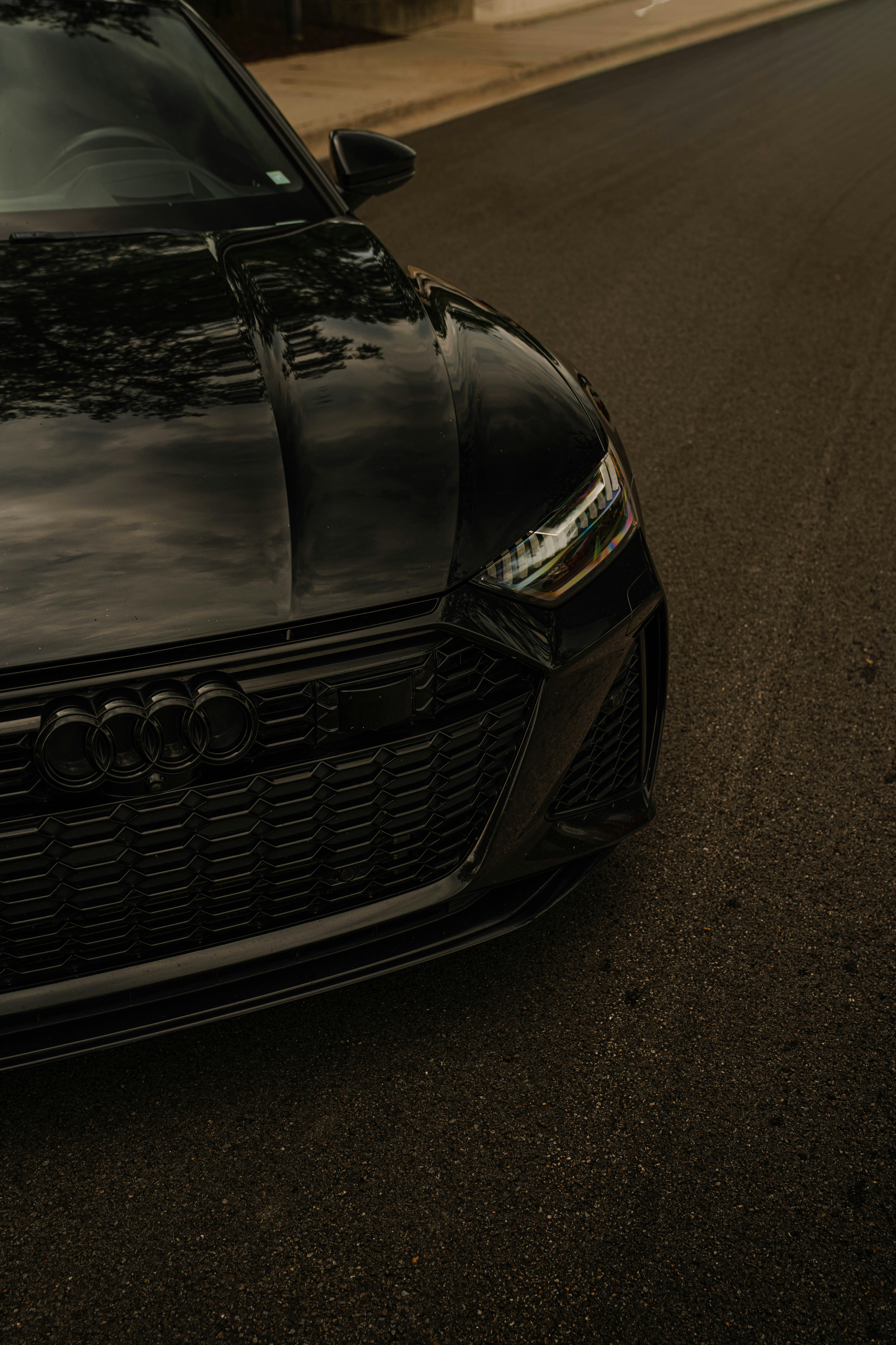Dynamic Front-Quarter Glow: Dark Audi Streaks on Quiet Street