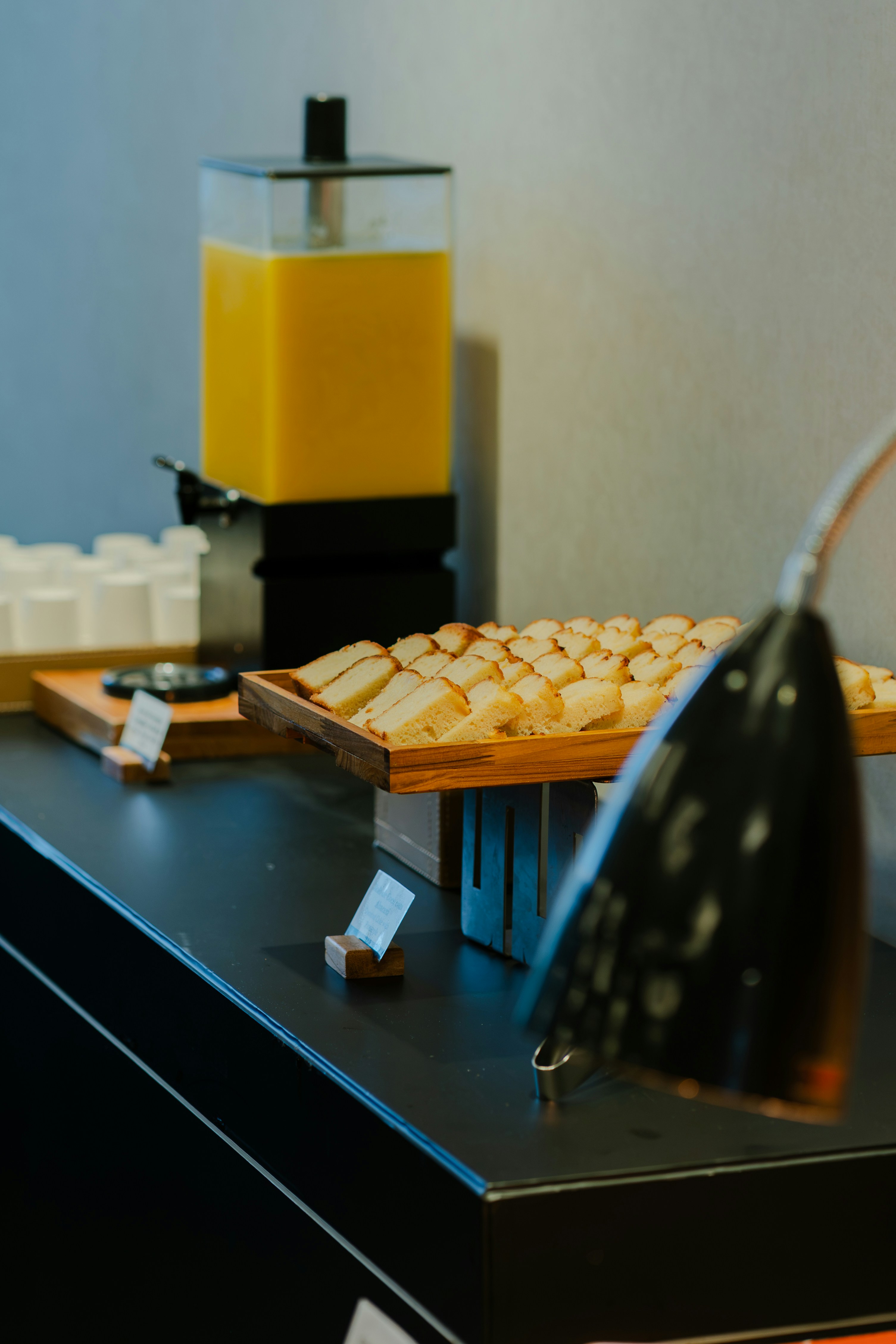 Morning Setup: Pastry Tray and Juicer in a Quiet Café Corner
