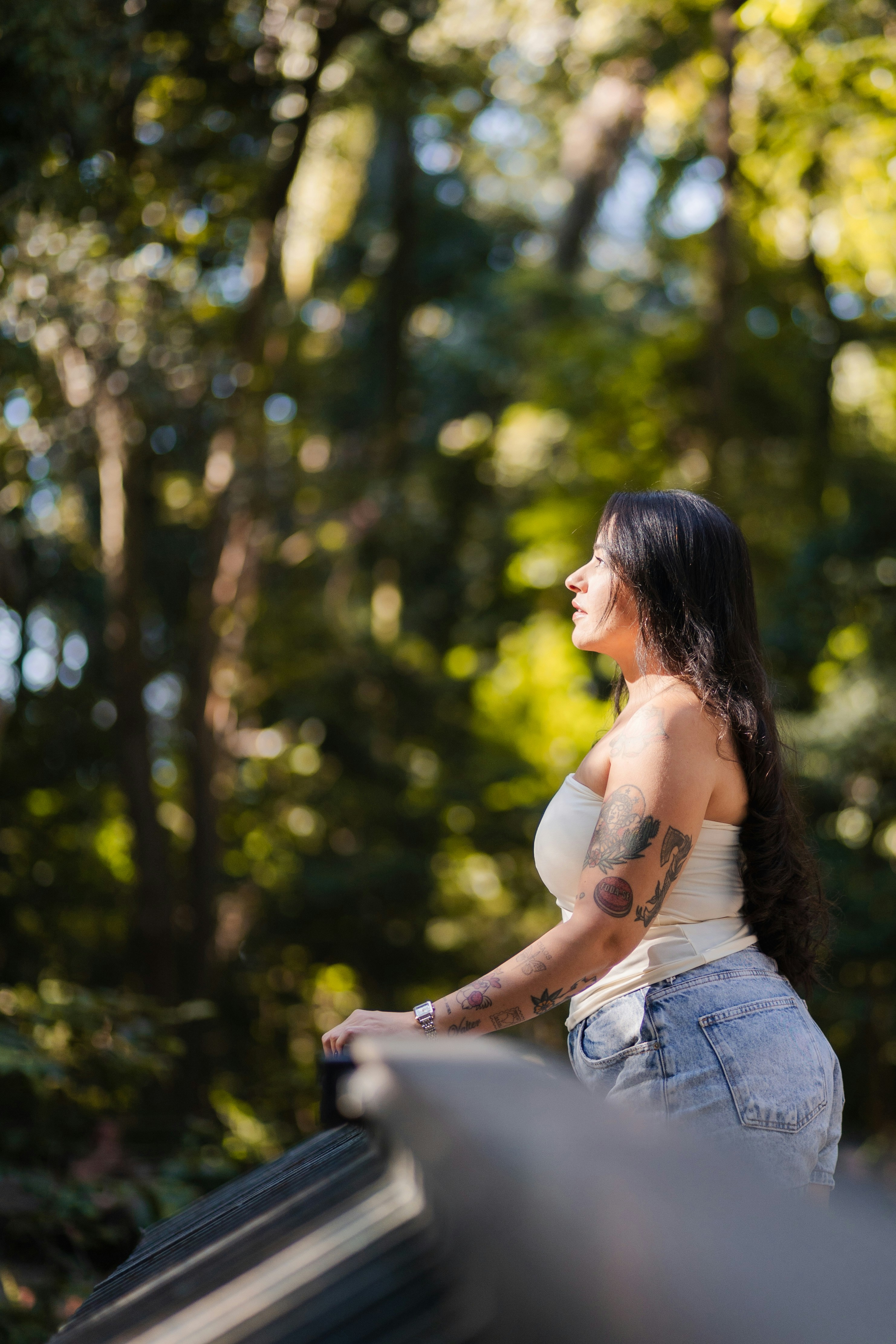 Sunlit Profile: Tattooed Arm and Outdoor Calm