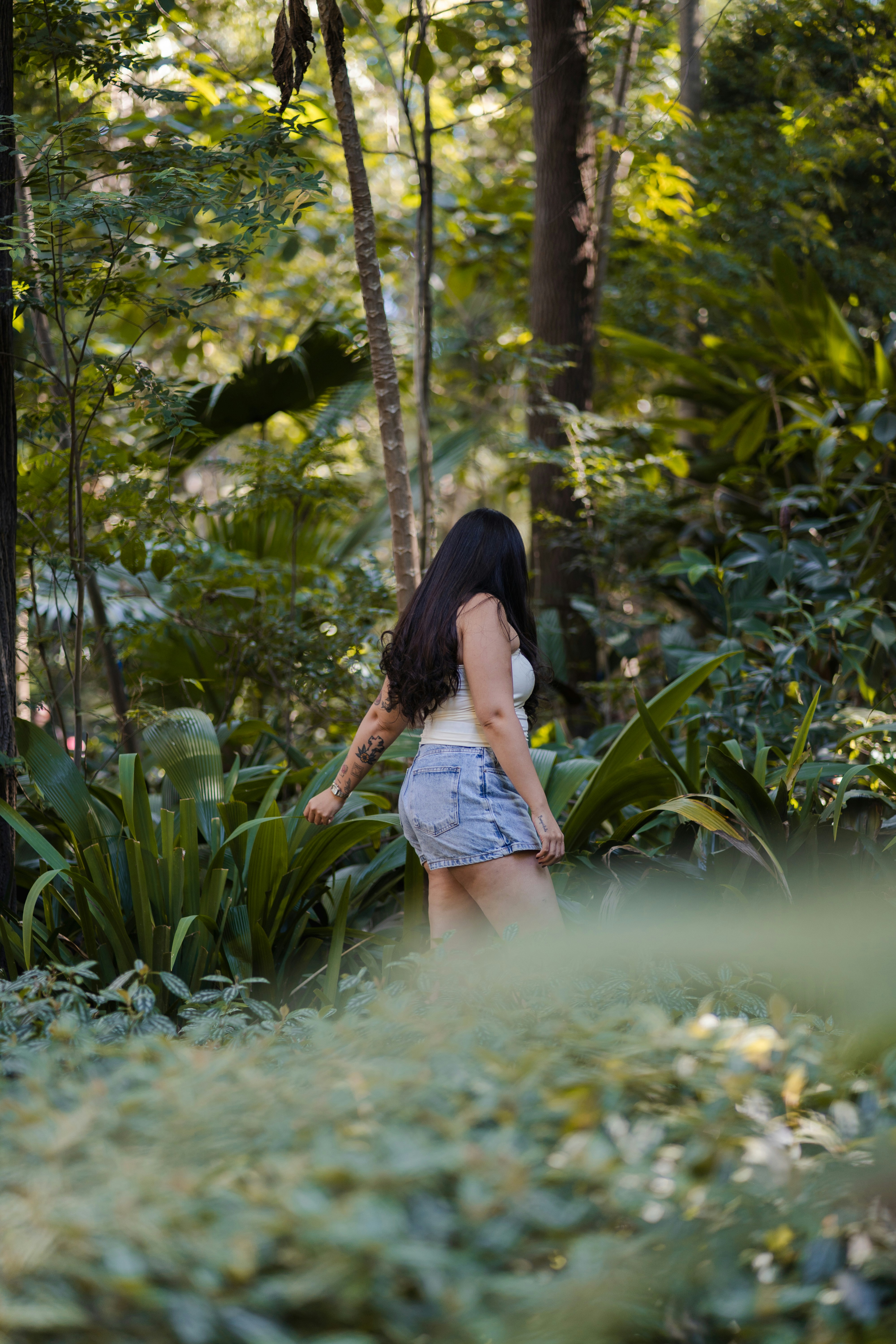 Hidden Traveler in a Lush Green Corridor