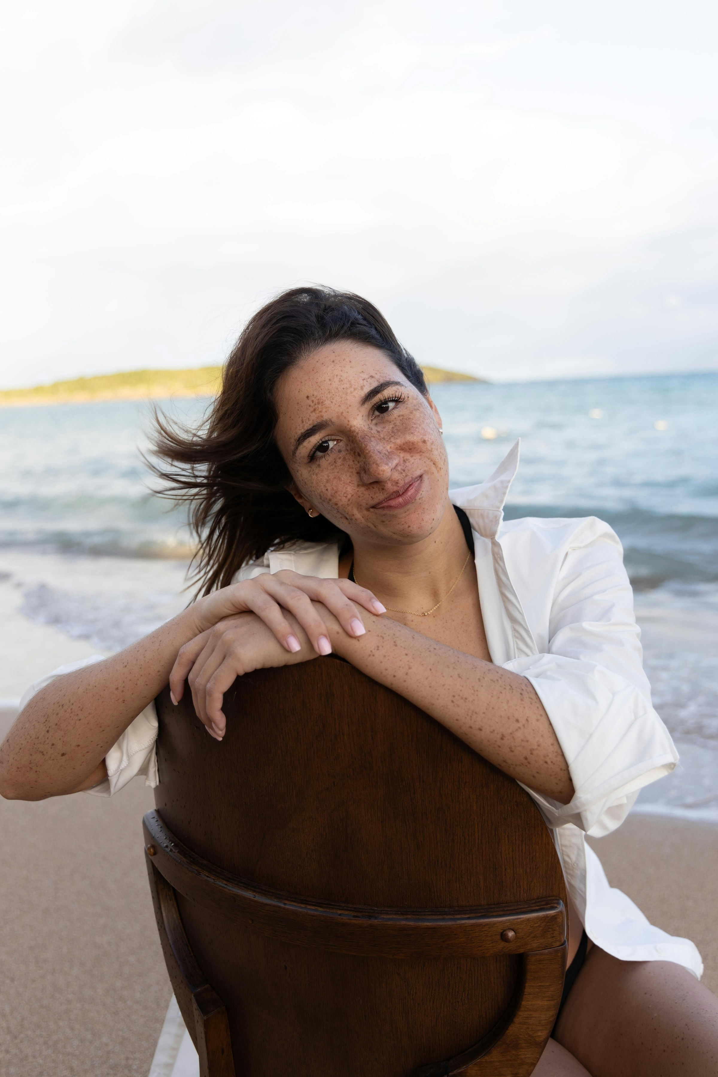 Beachside Confidence: A Quiet Moment with Freckled Light and White Shirt