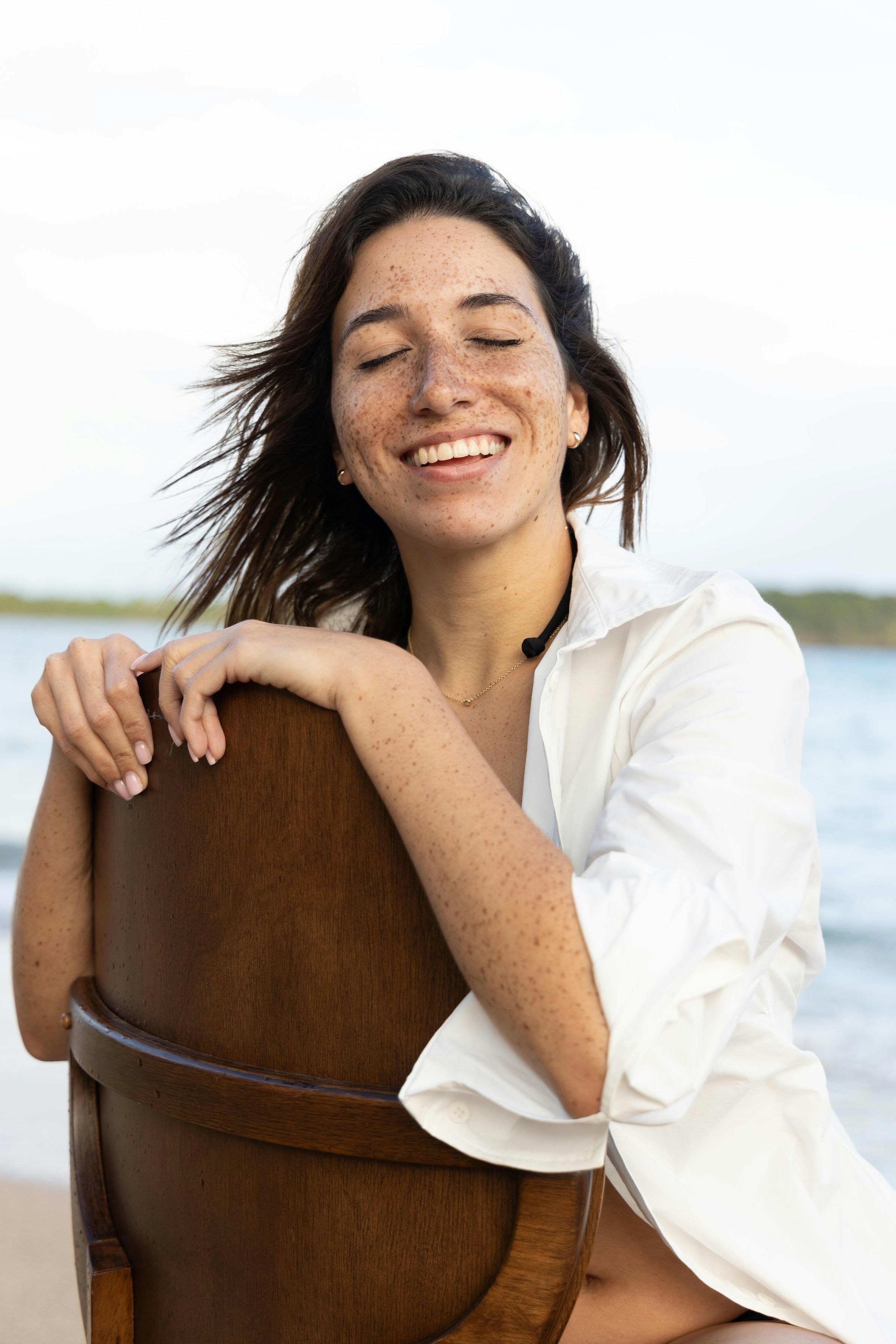 Sunlit Smile Over a Wooden Backdrop by the Shore