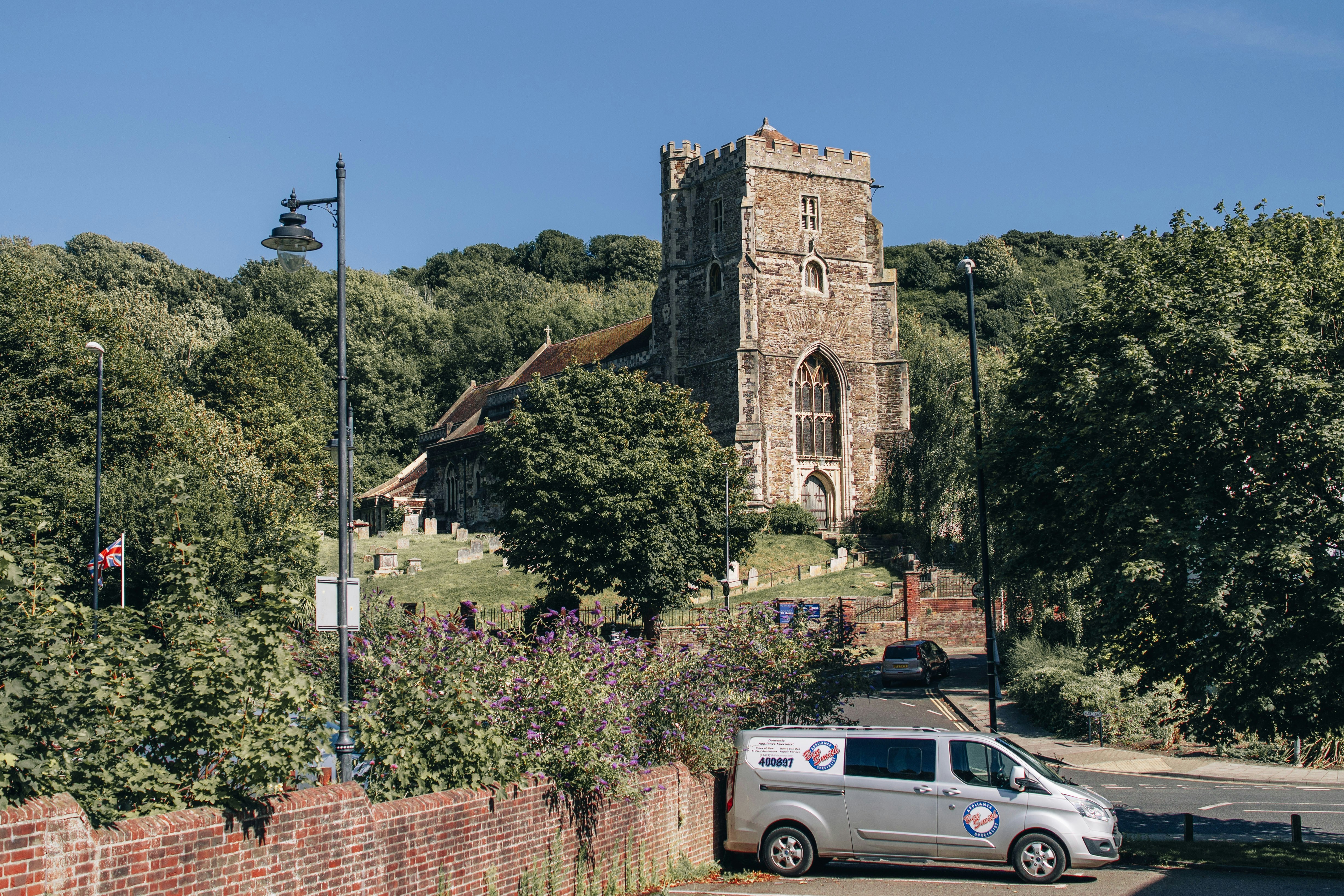 Castle Gatehouse and Parked Service van under a Blue Sky