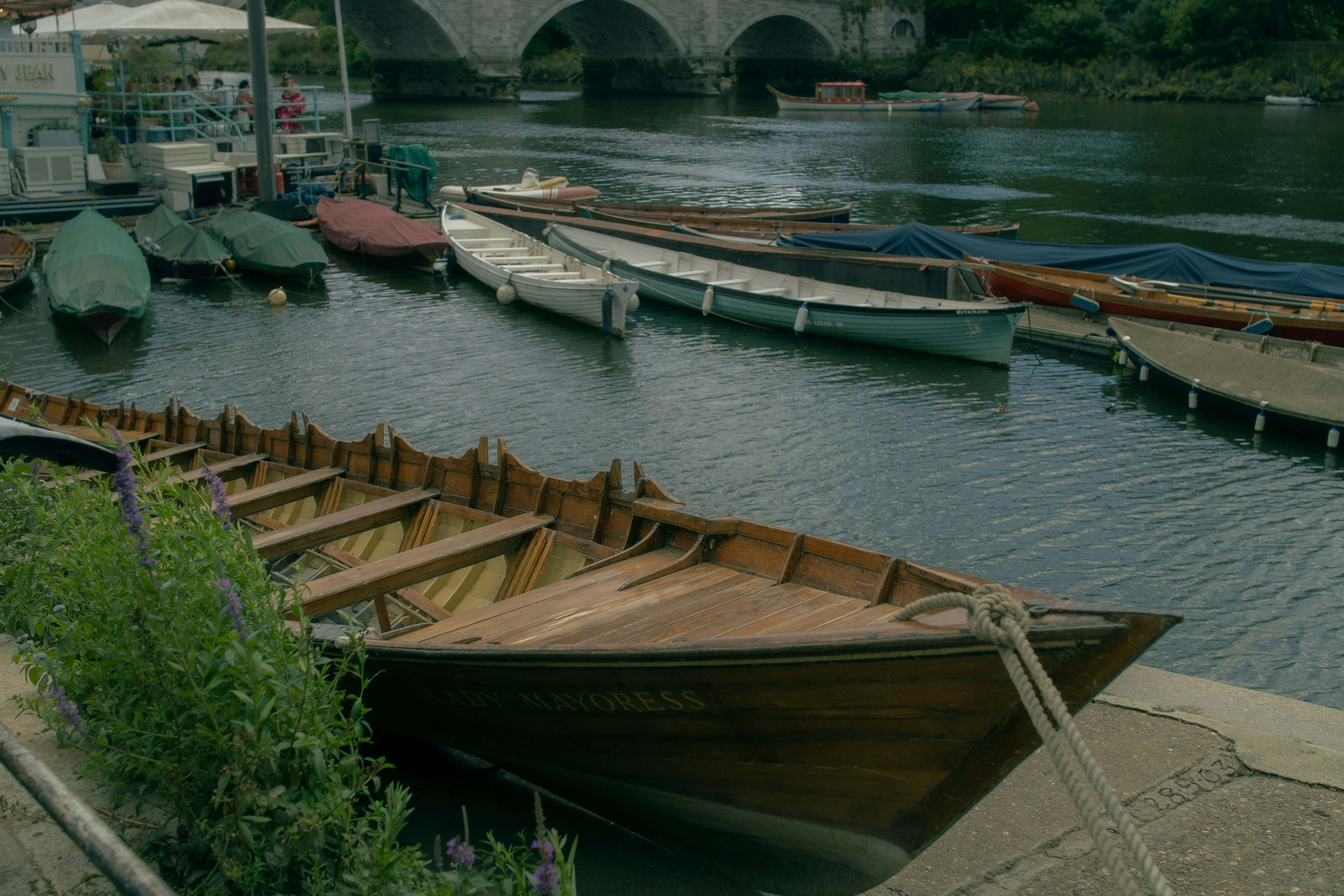 Dockside Silence: Wood Boat at the Riverbank