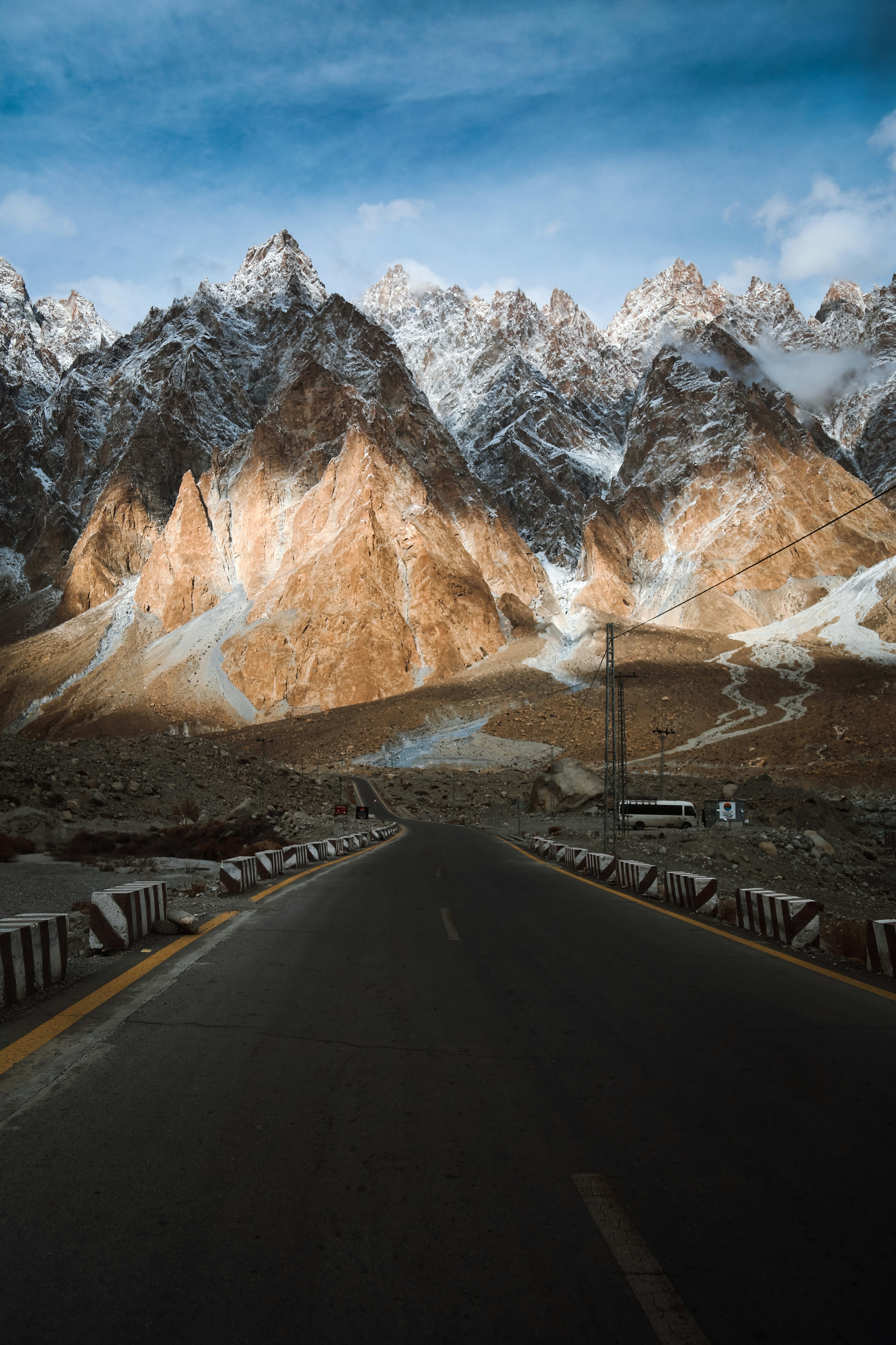Road toward the jagged sunlit peaks