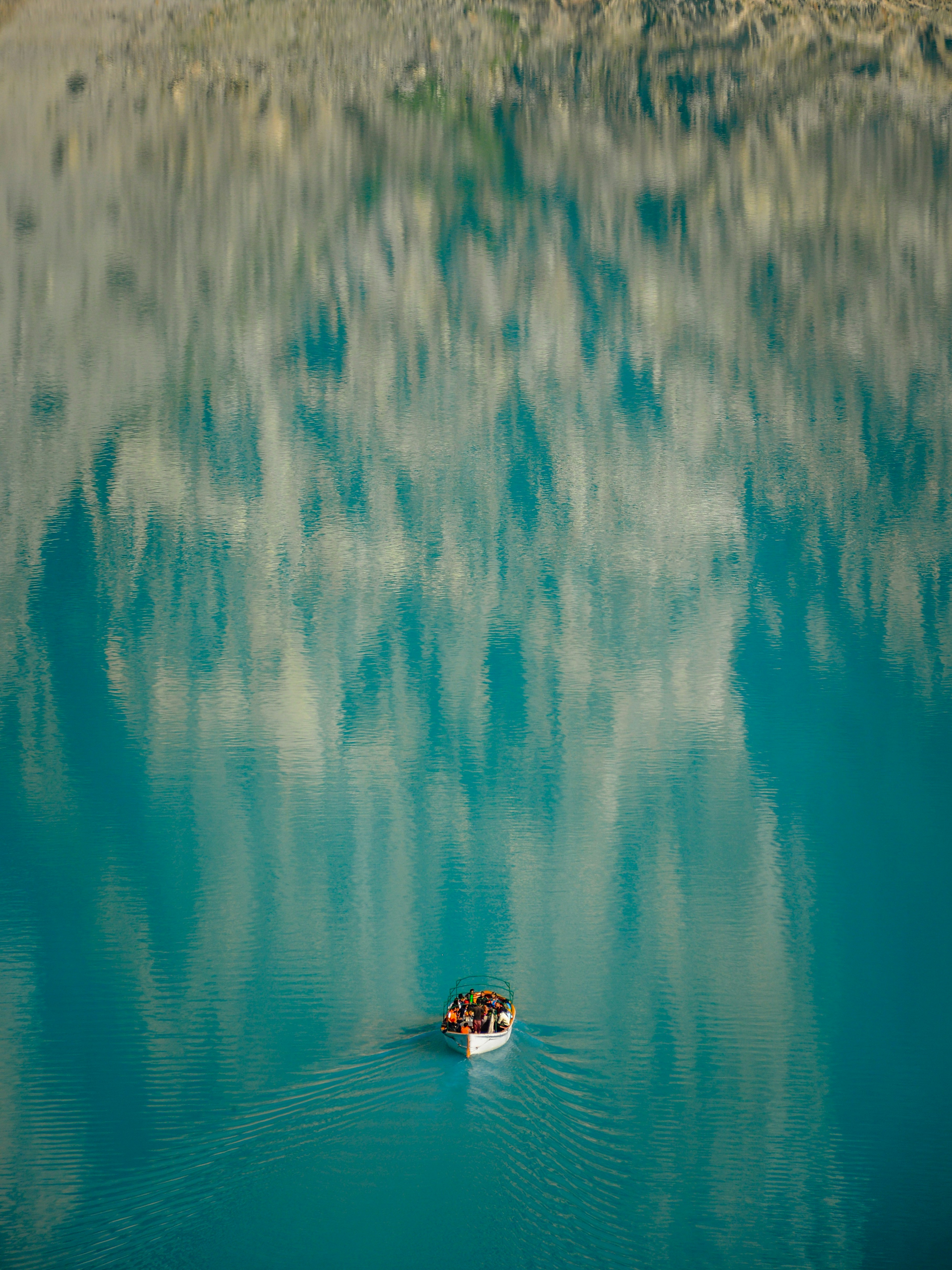 Boat Carries The Quiet Mirror of Mountain Sky