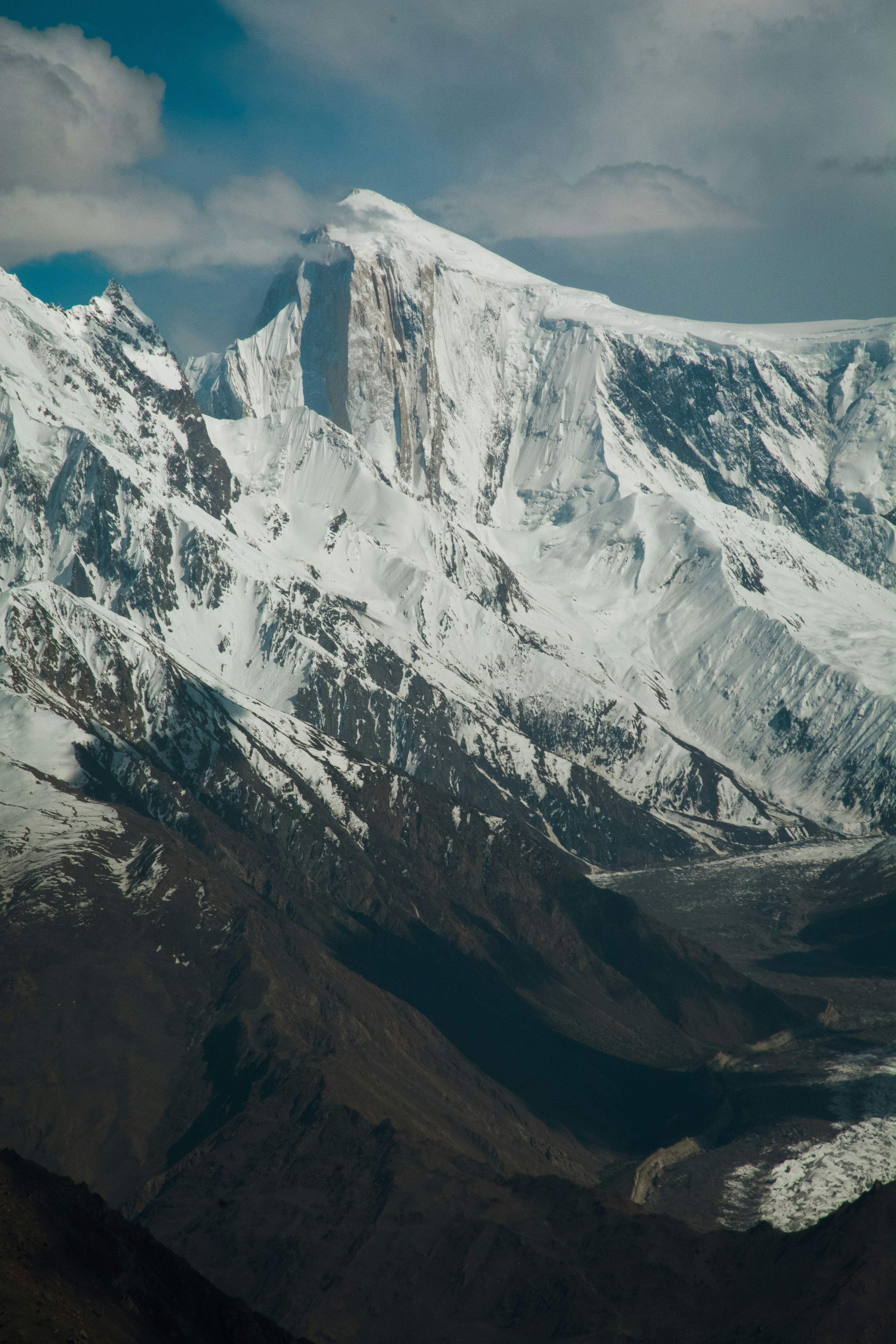 Summit Crown: A Majestic Snow-Wedged Peak Reaches into the Blue