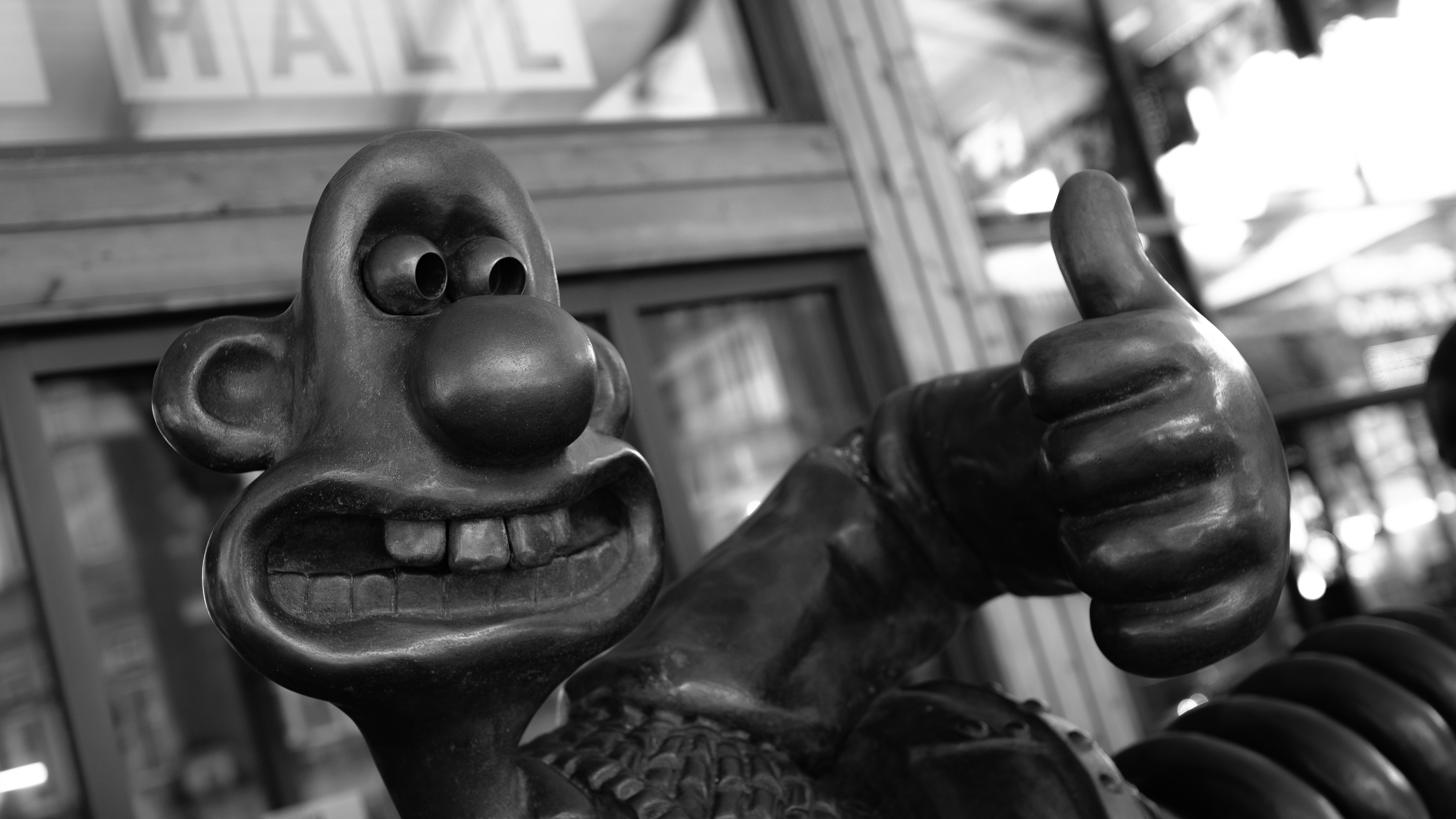 Grinning Muppet Titan: A Clay Sculpture Thumbs Up