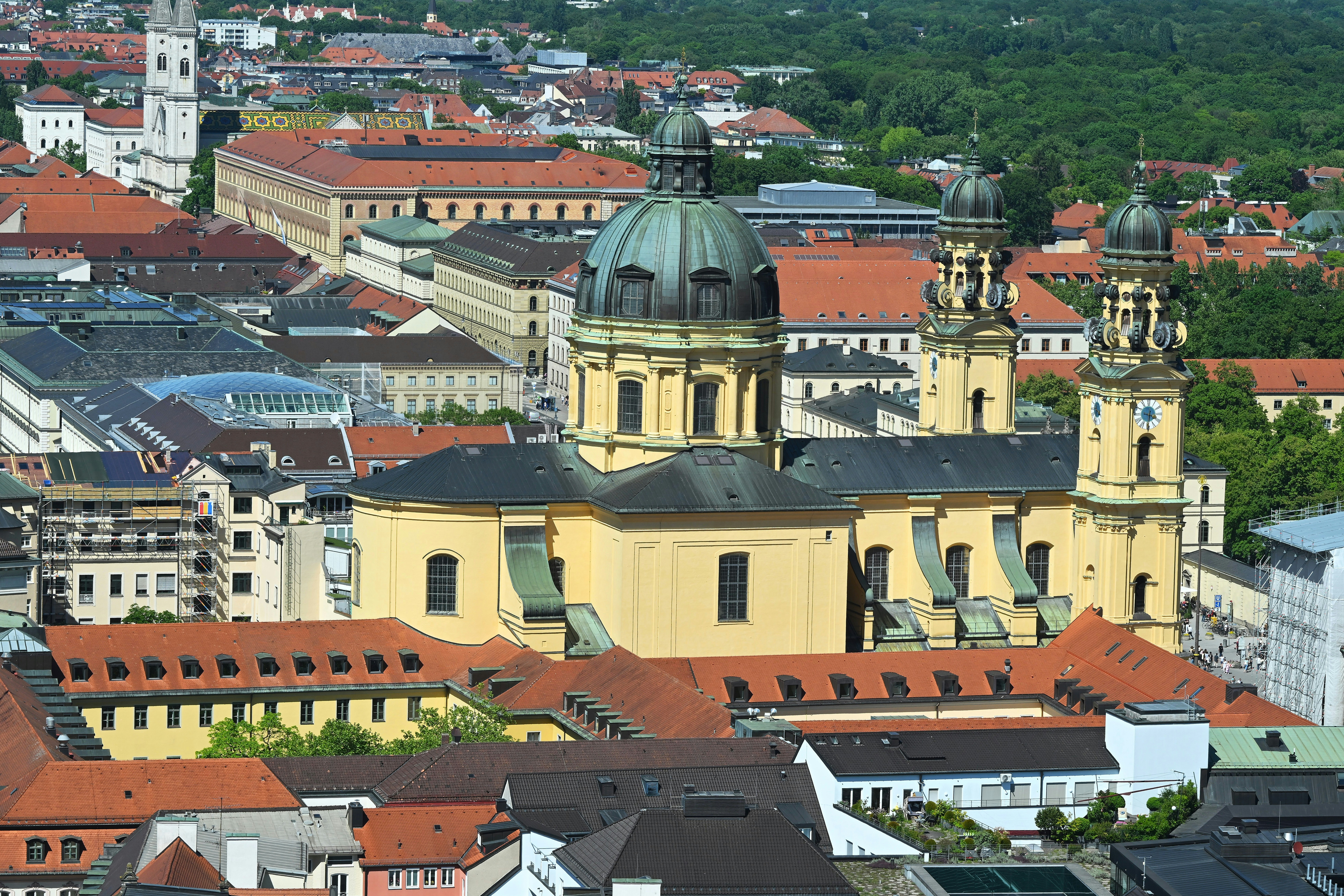 Domed Cathedral and Terracotta Roofscape Over an Alpine City