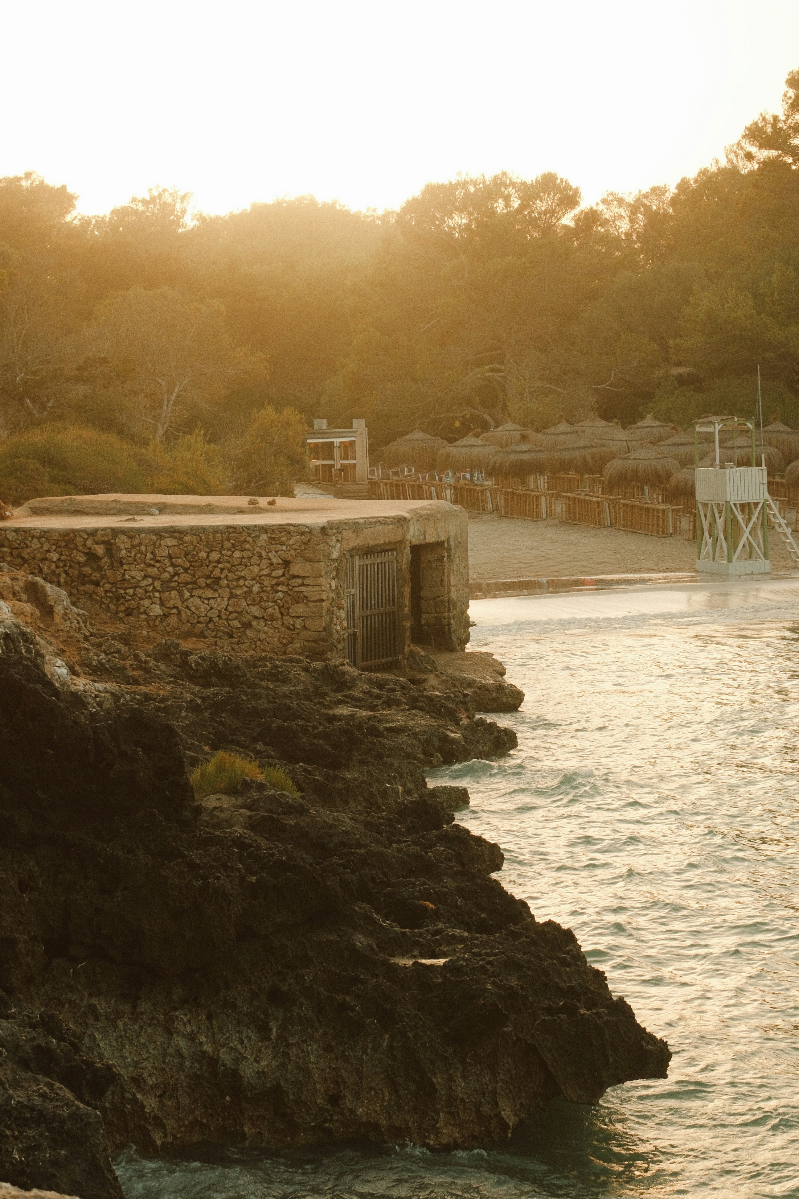 Sunset over the cliffside resort and calm sea