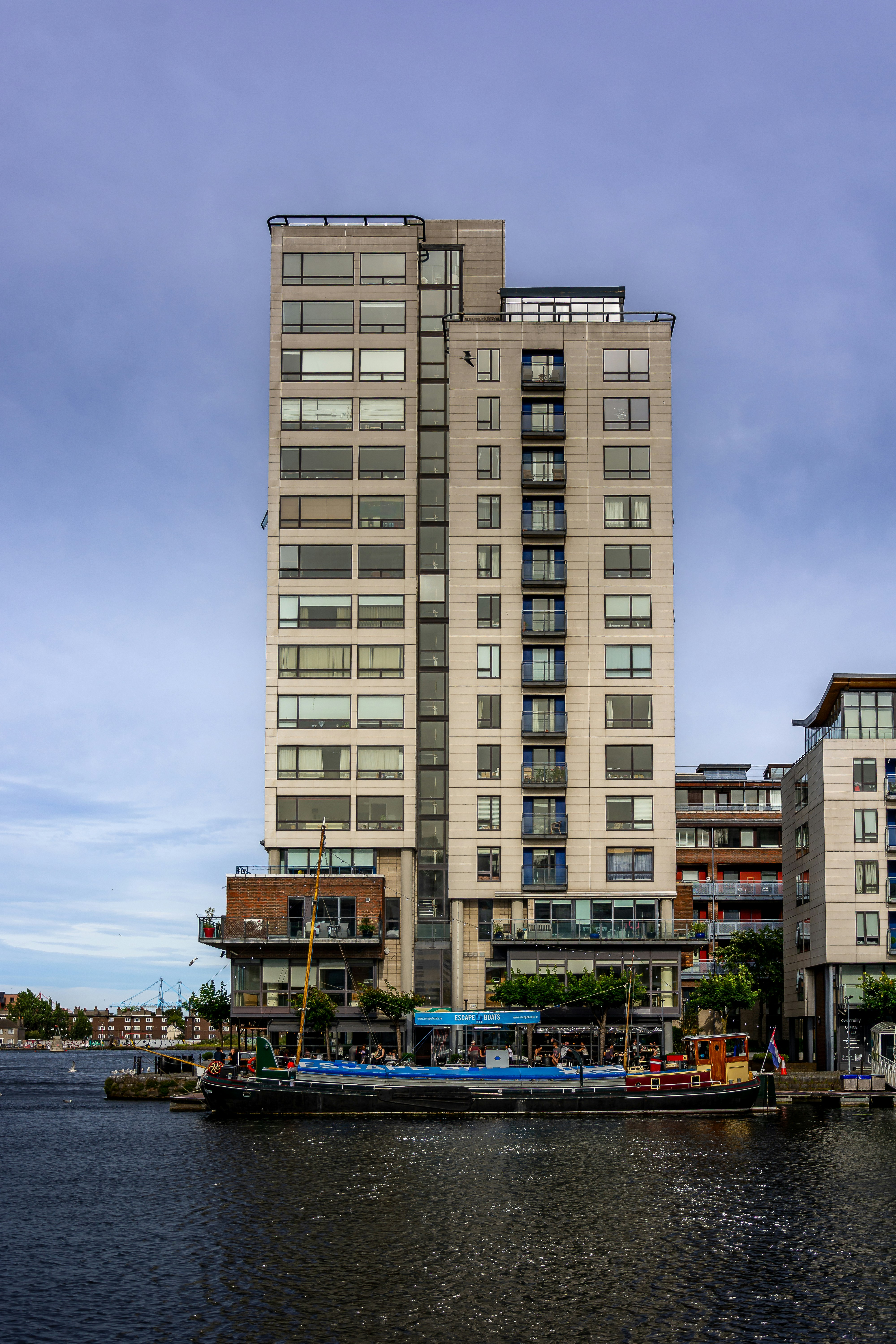 Harbor Tower: Glass Facade Rising Over a Quiet Waterway