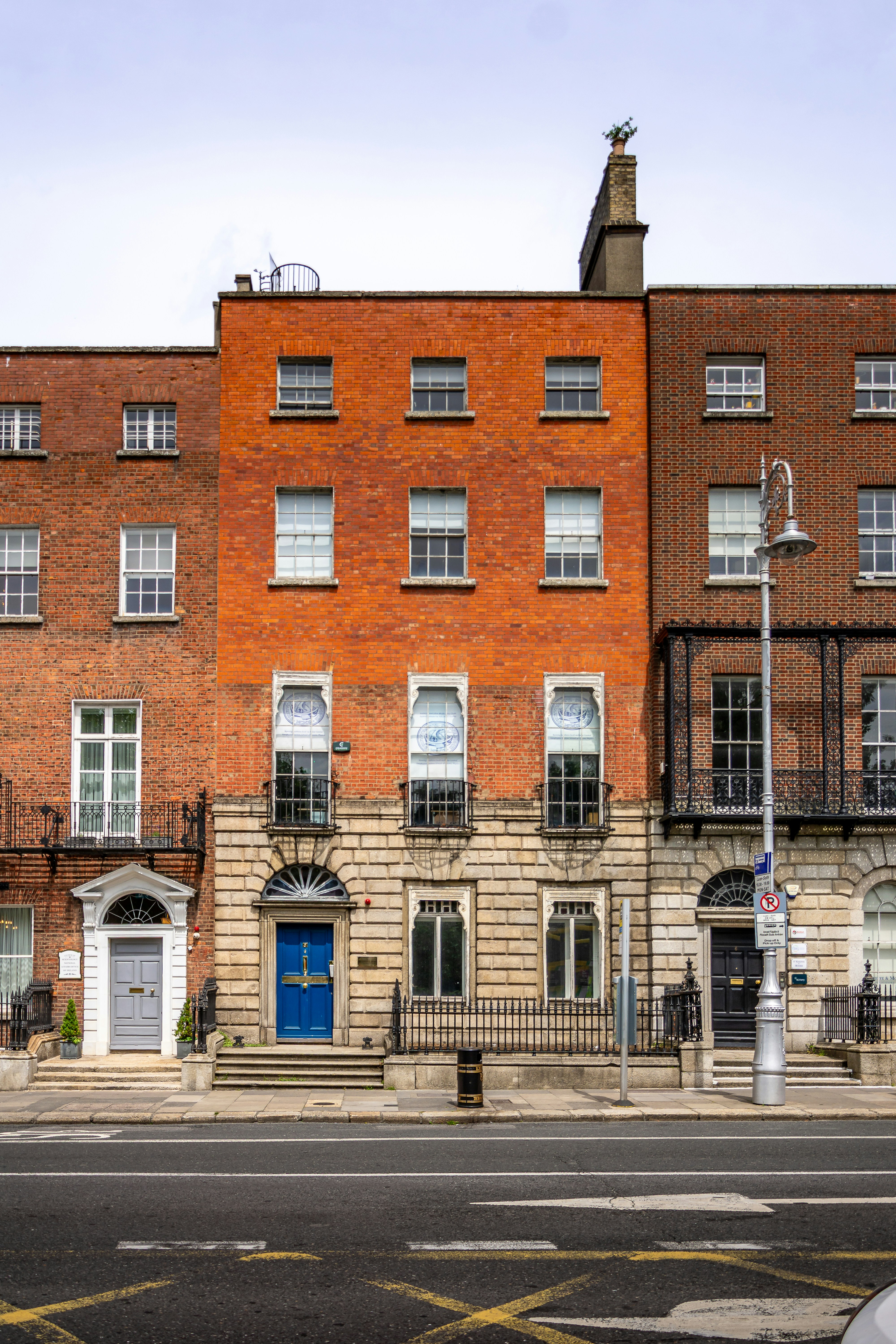 Brick Facade Chorus: A Row of Urban Townhouses Bordered by a Quiet Street