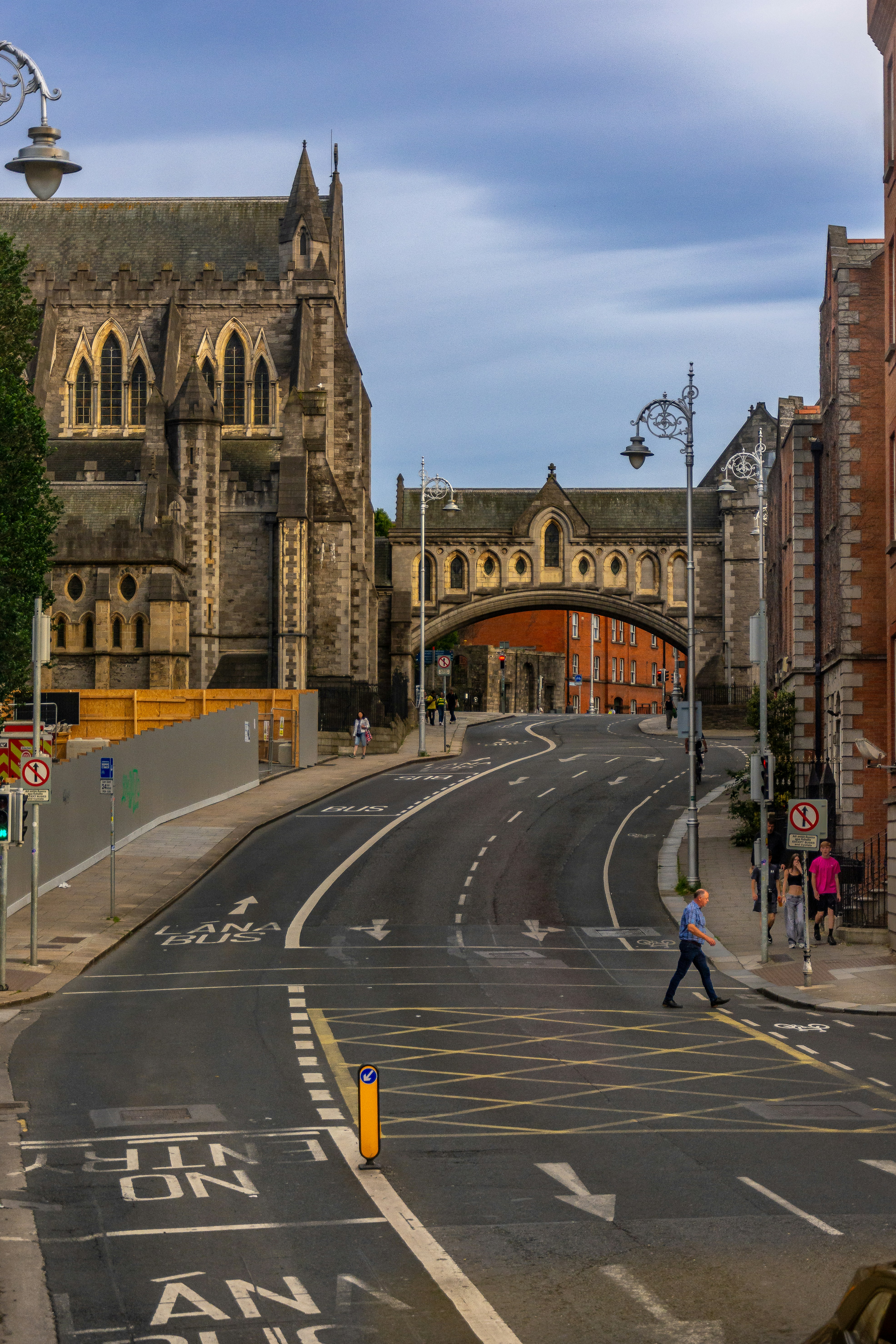 Gateway to the Cathedral: Stone Archway Framing a Busy Street