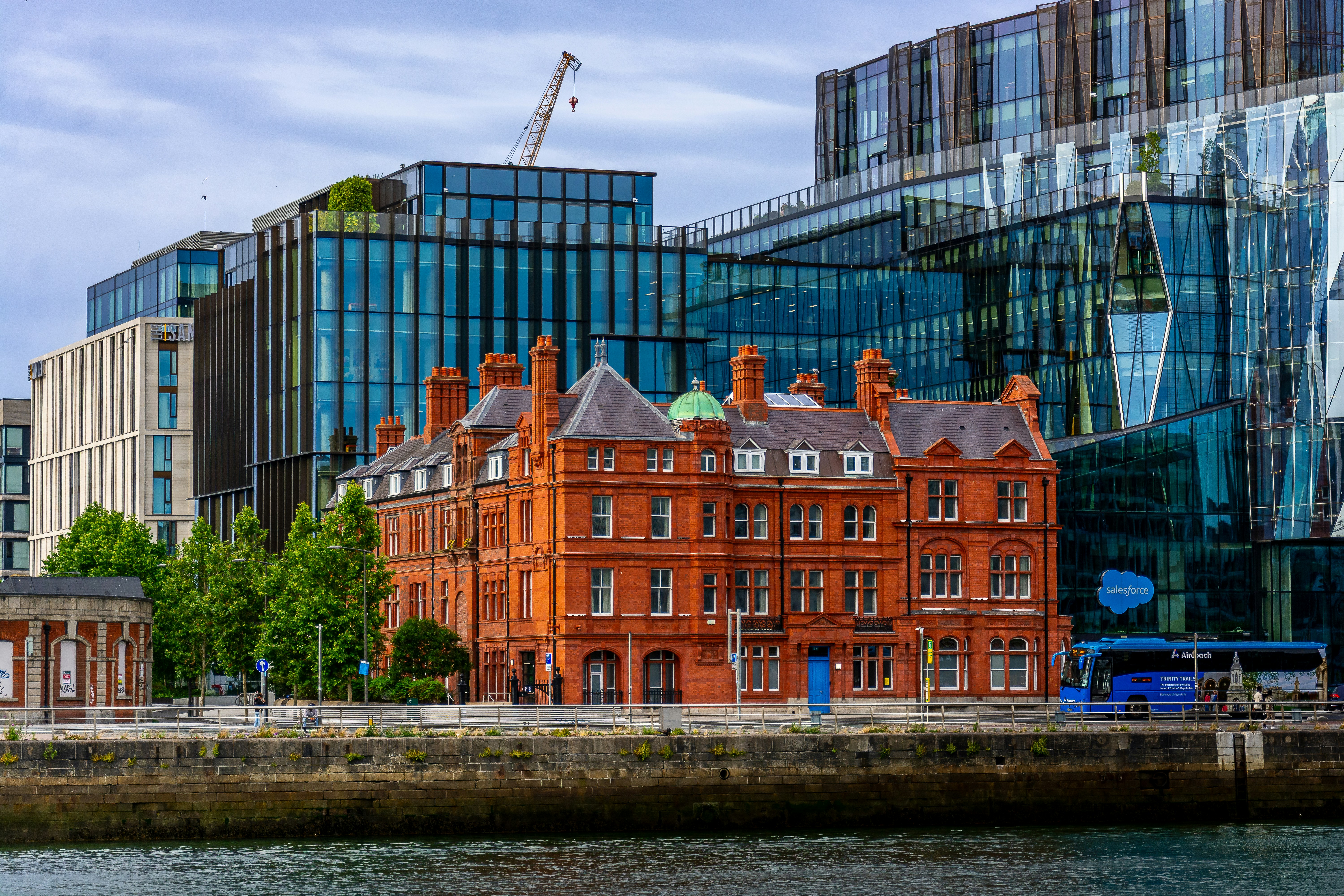 Brick-red House Among Glass Giants by the Waterfront