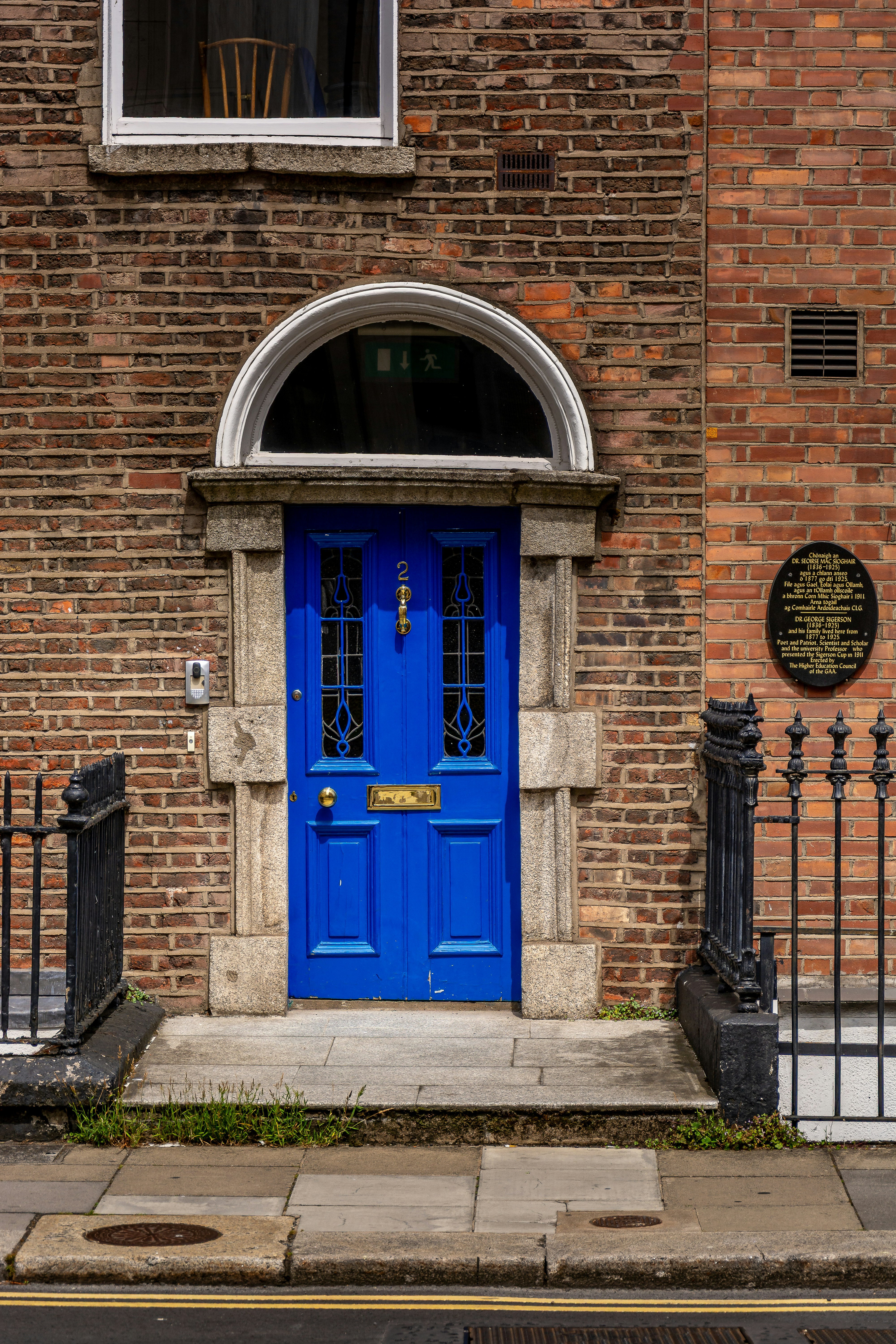 A Bold Blue Door Amid Brickwork and Ironwork