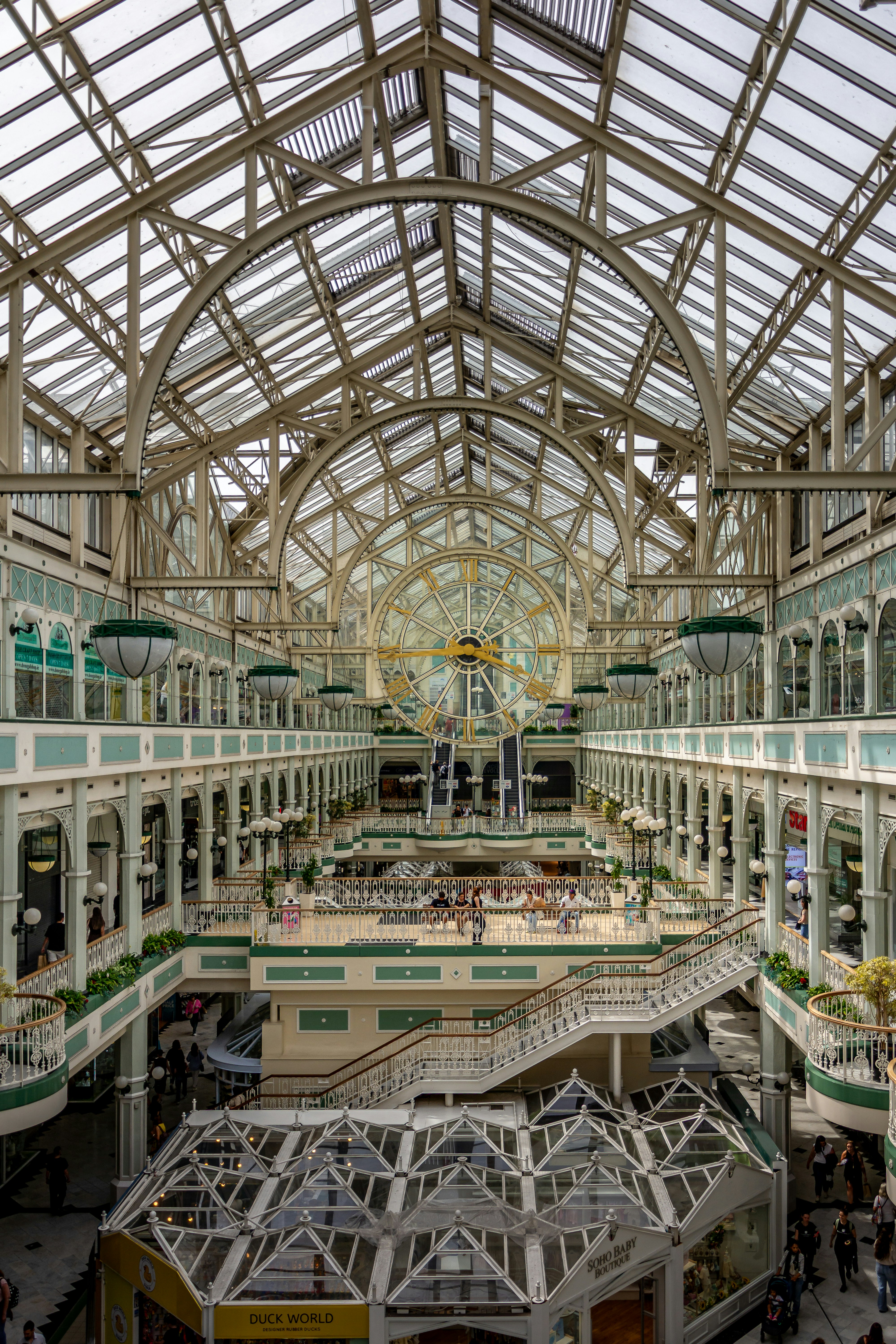 Crystal Atrium: Arching Glass and Geometric Steel in the Sunlit Mall